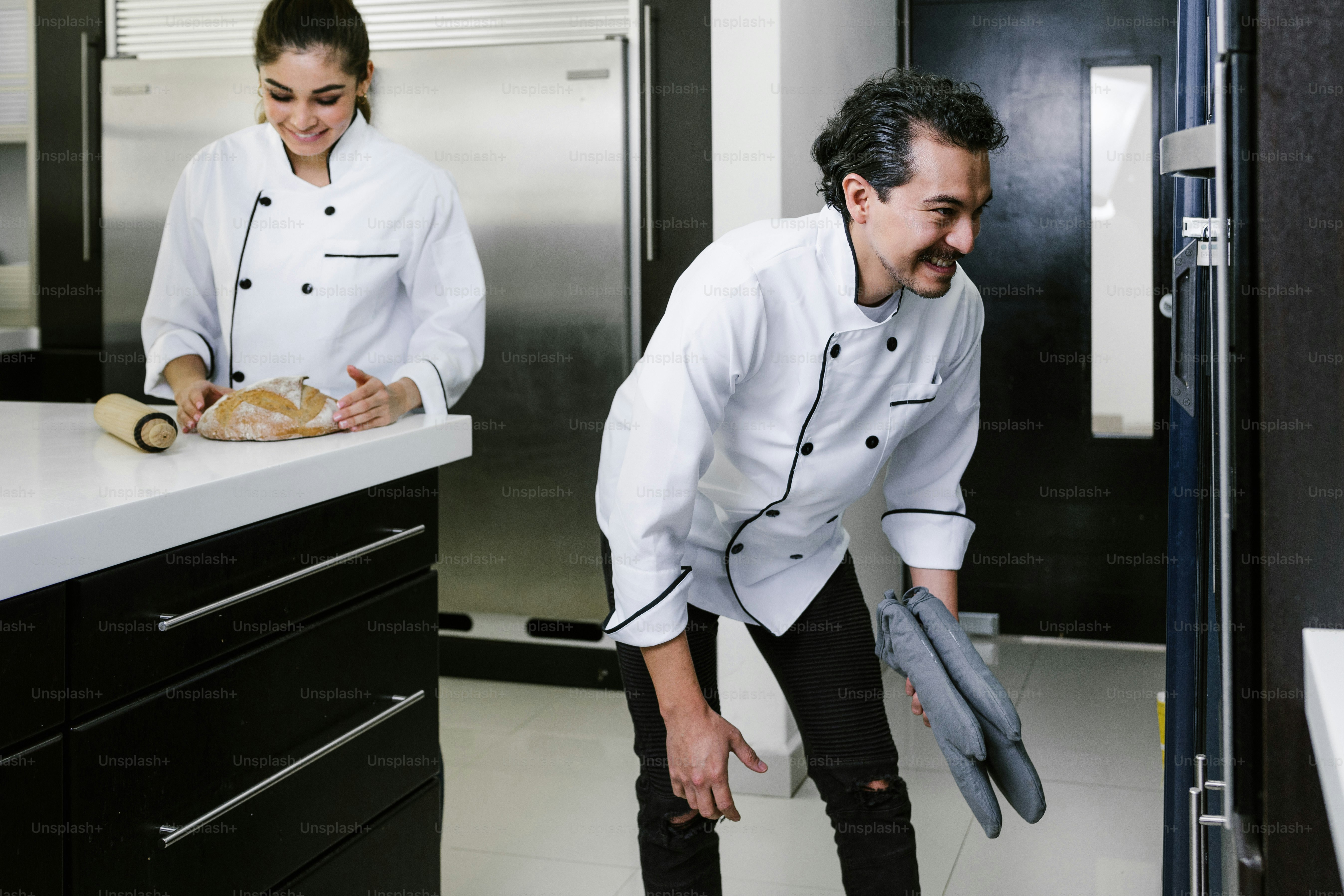 Young Latin man baker and baking bread on oven at kitchen in Mexico ...