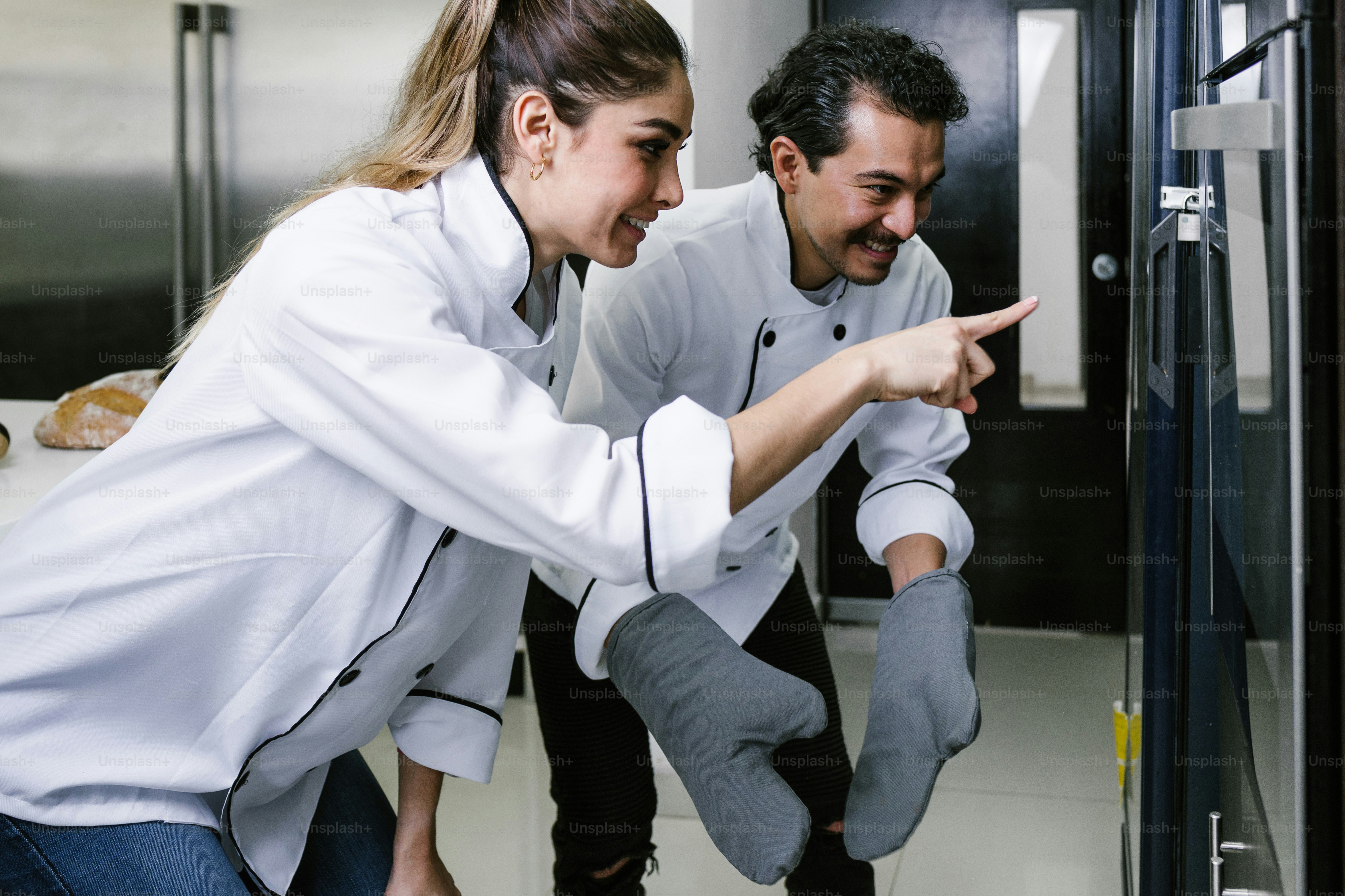 Young Latin man baker and baking bread on oven at kitchen in Mexico ...