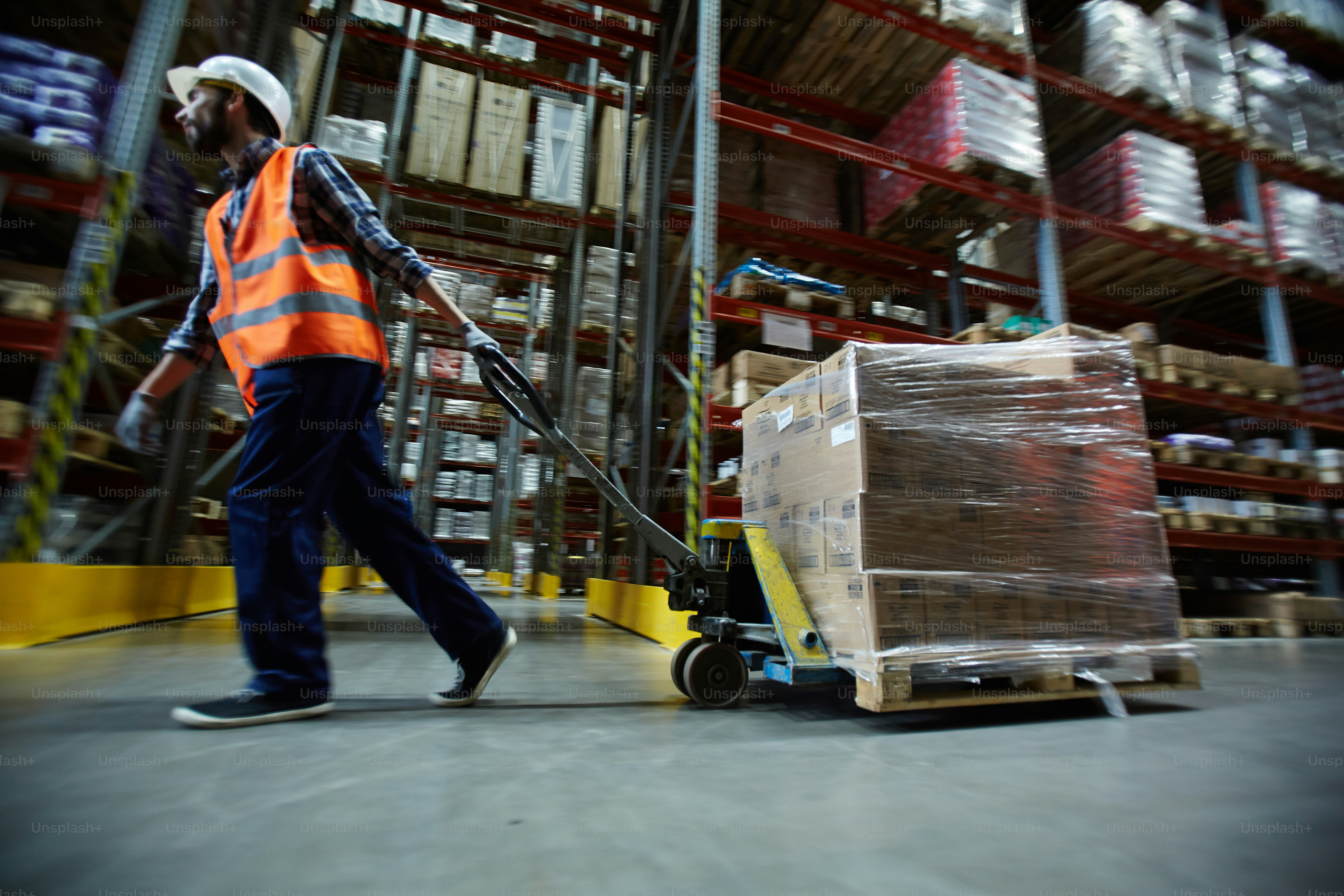 Loader with forklift moving along shelves with goods photo – Moving up ...