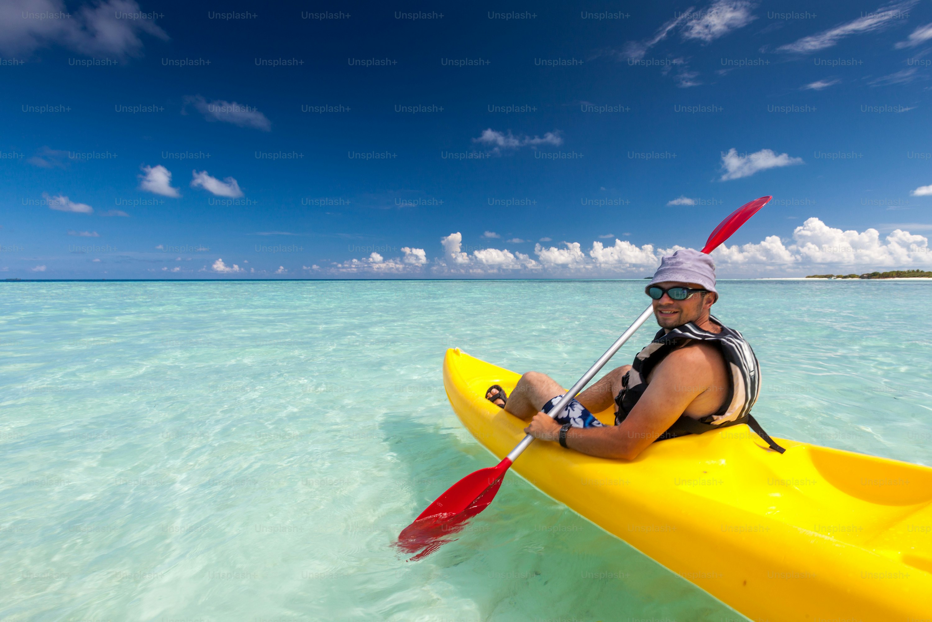 Young caucasian man kayaking in sea at Maldives photo – Kayaking Image ...