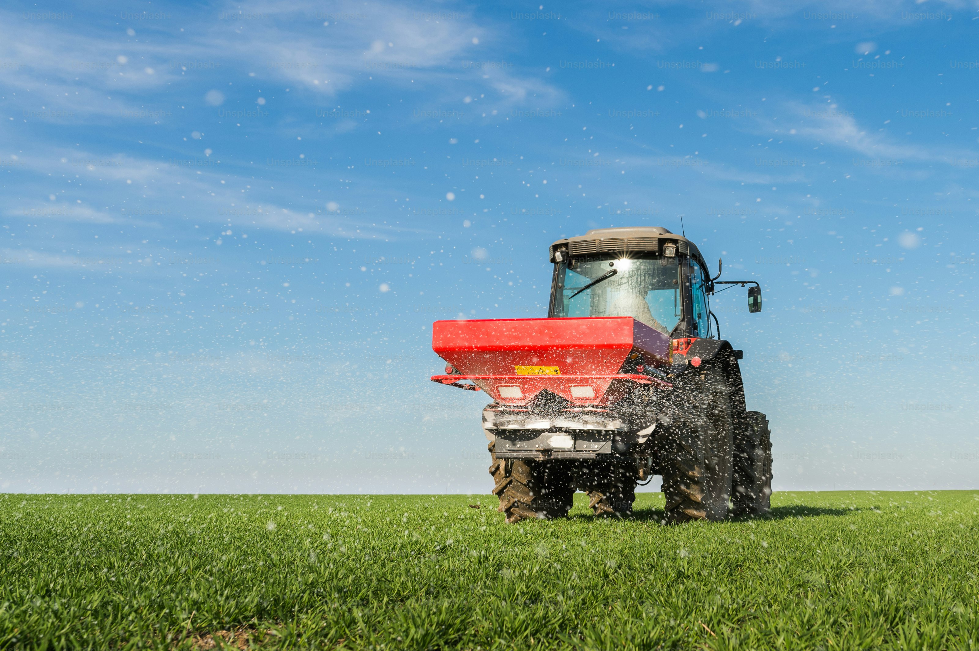 Tractor fertilizing in wheat field photo – Farm Image on Unsplash