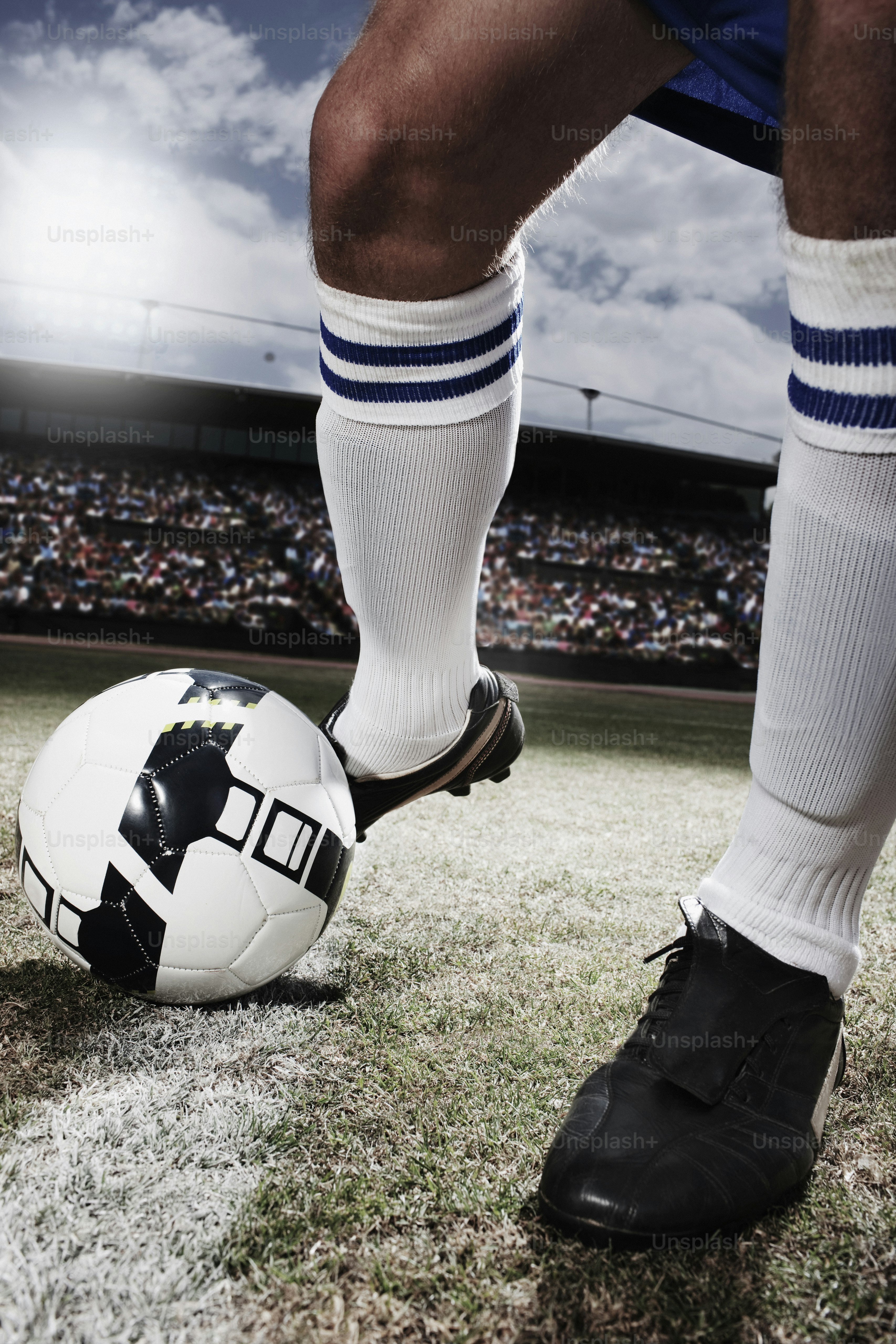 A soccer player with his foot on a soccer ball photo – Sports betting ...
