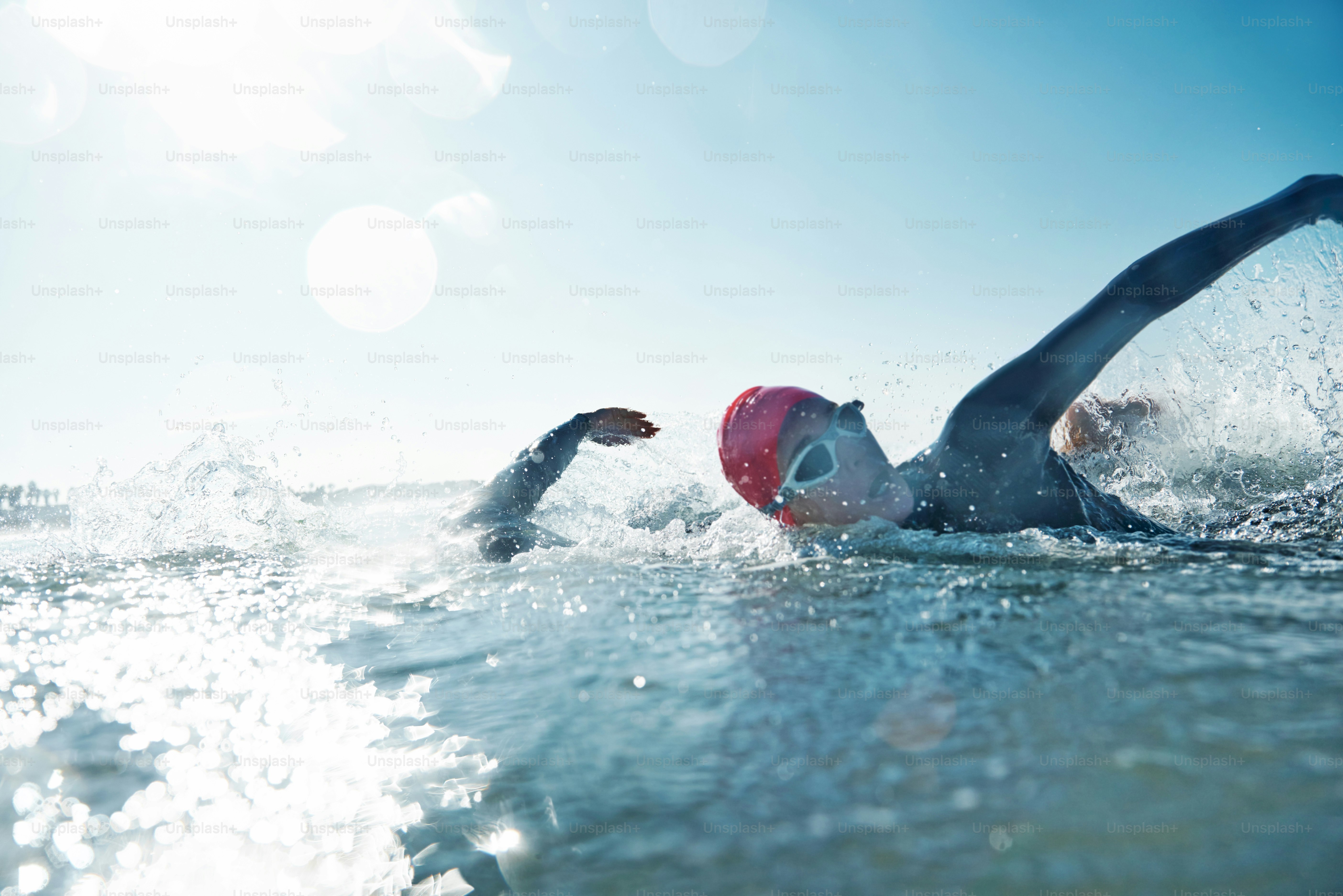 Two athletes competing in a open water swimming race photo – Copy space ...