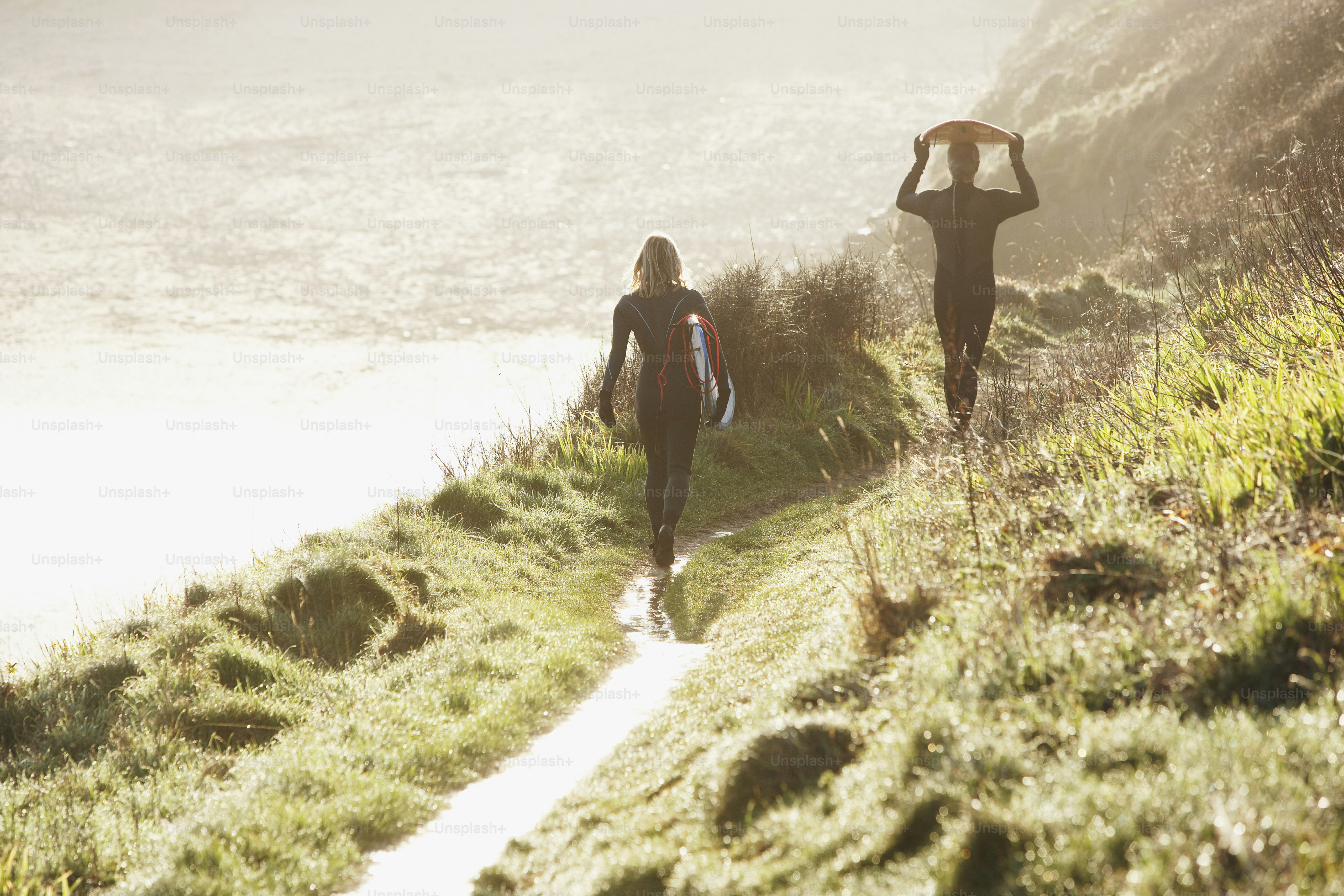 A couple of people that are walking down a hill photo – High angle view ...