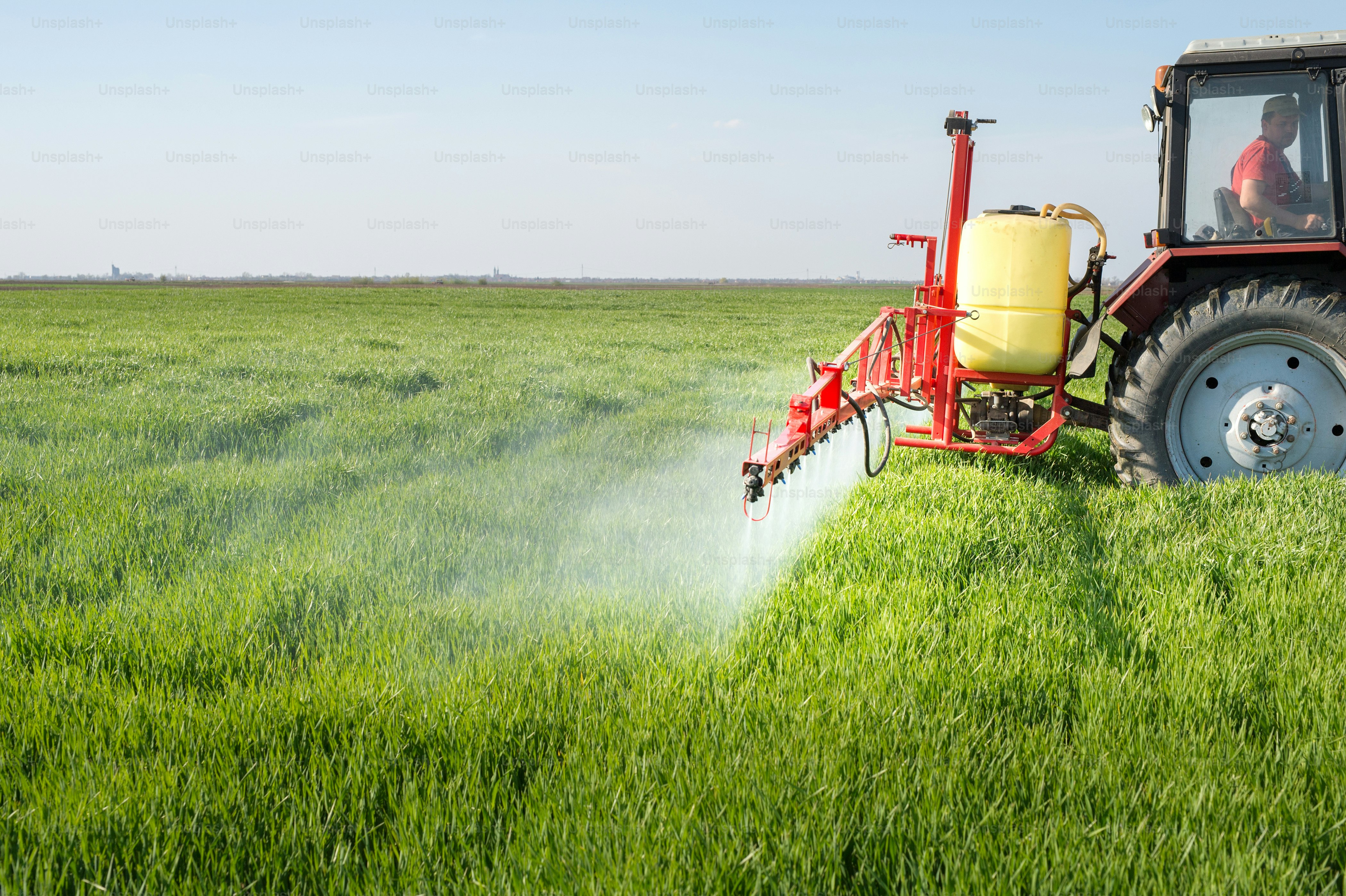 Tractor spraying wheat field with sprayer photo – Land Image on Unsplash