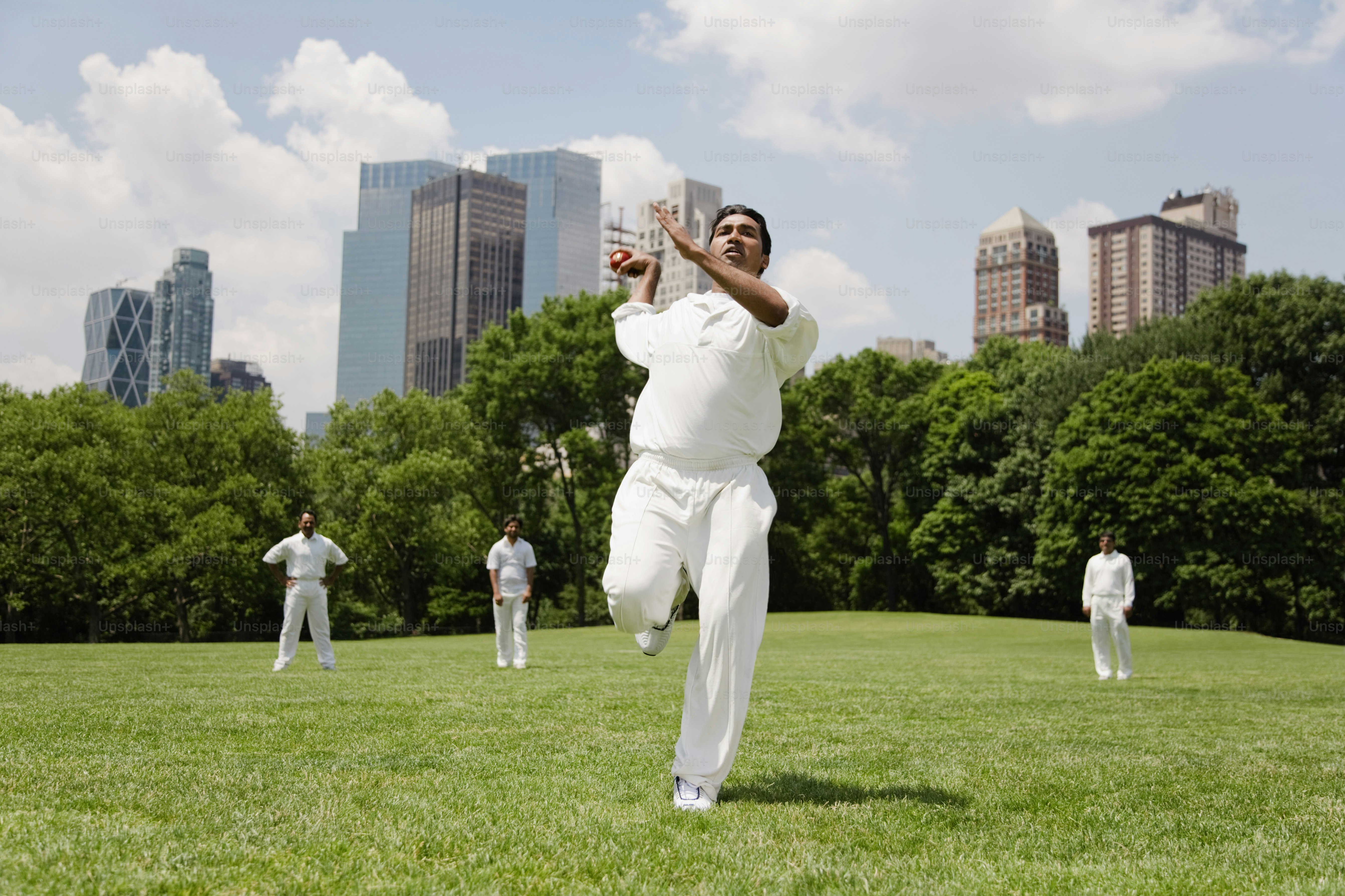 A man in a white uniform playing a game of cricket photo – Sport Image ...