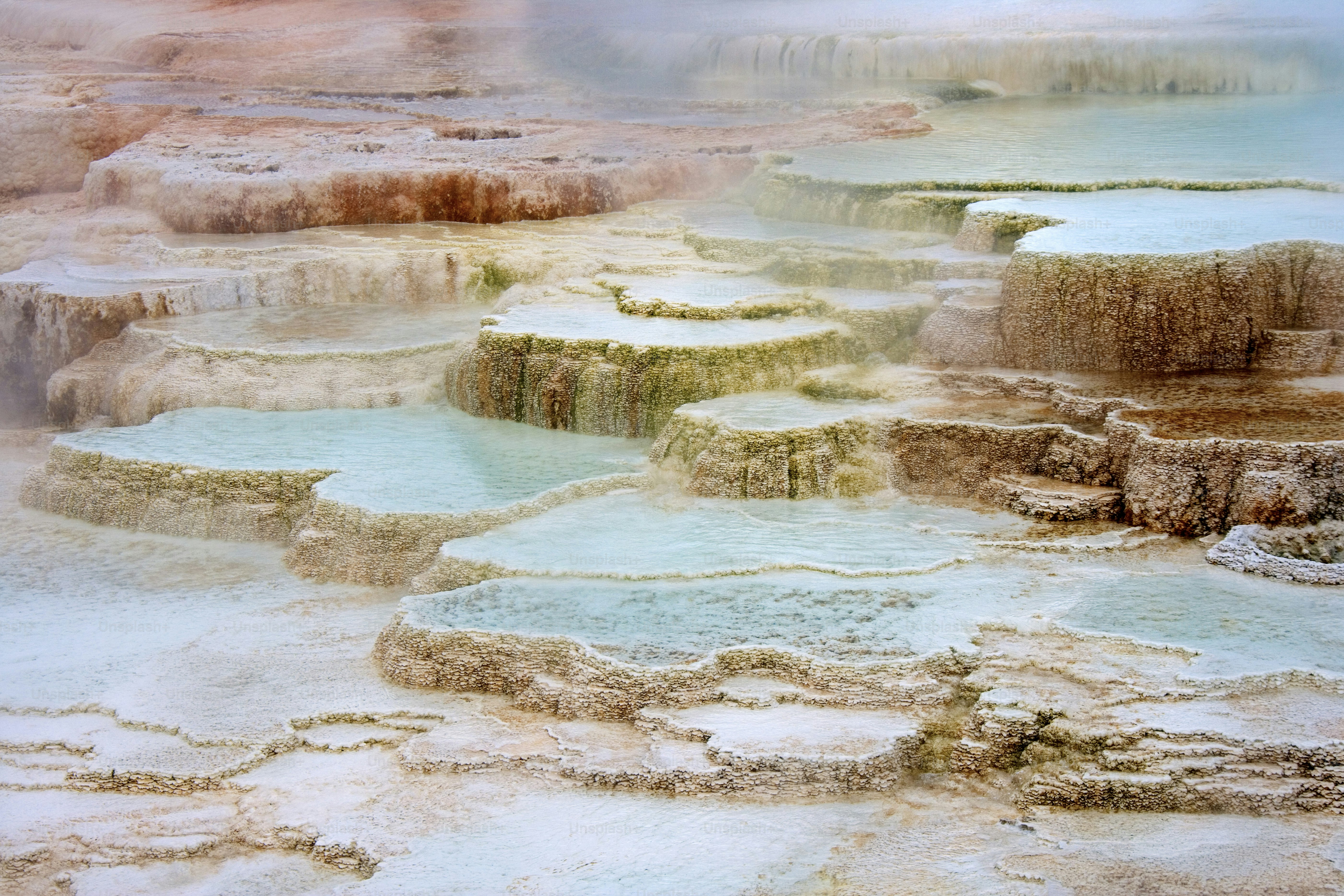 A hot spring in the middle of a desert photo – Yellowstone national ...