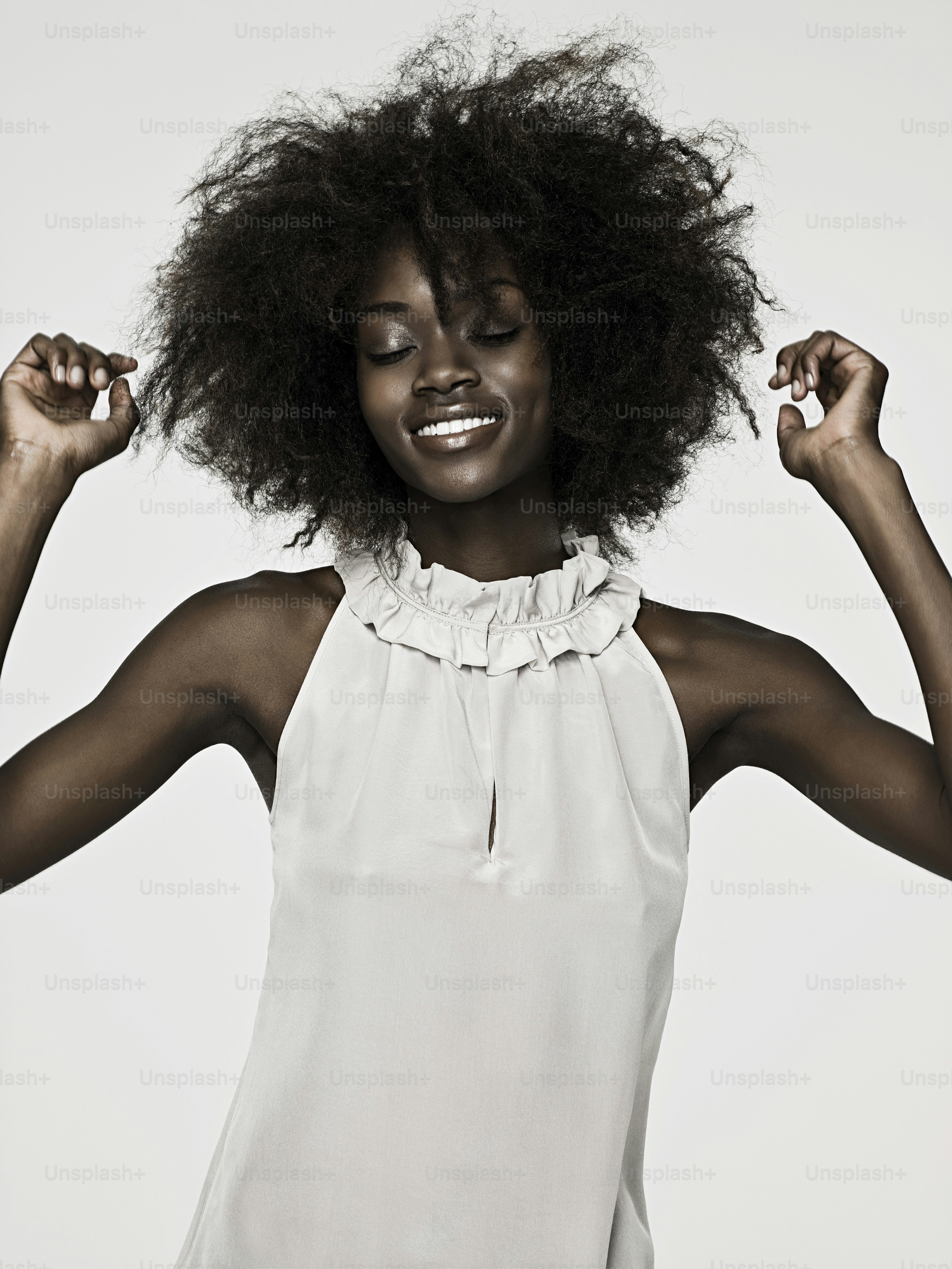 A woman with an afro is posing for a picture photo – African-american ...