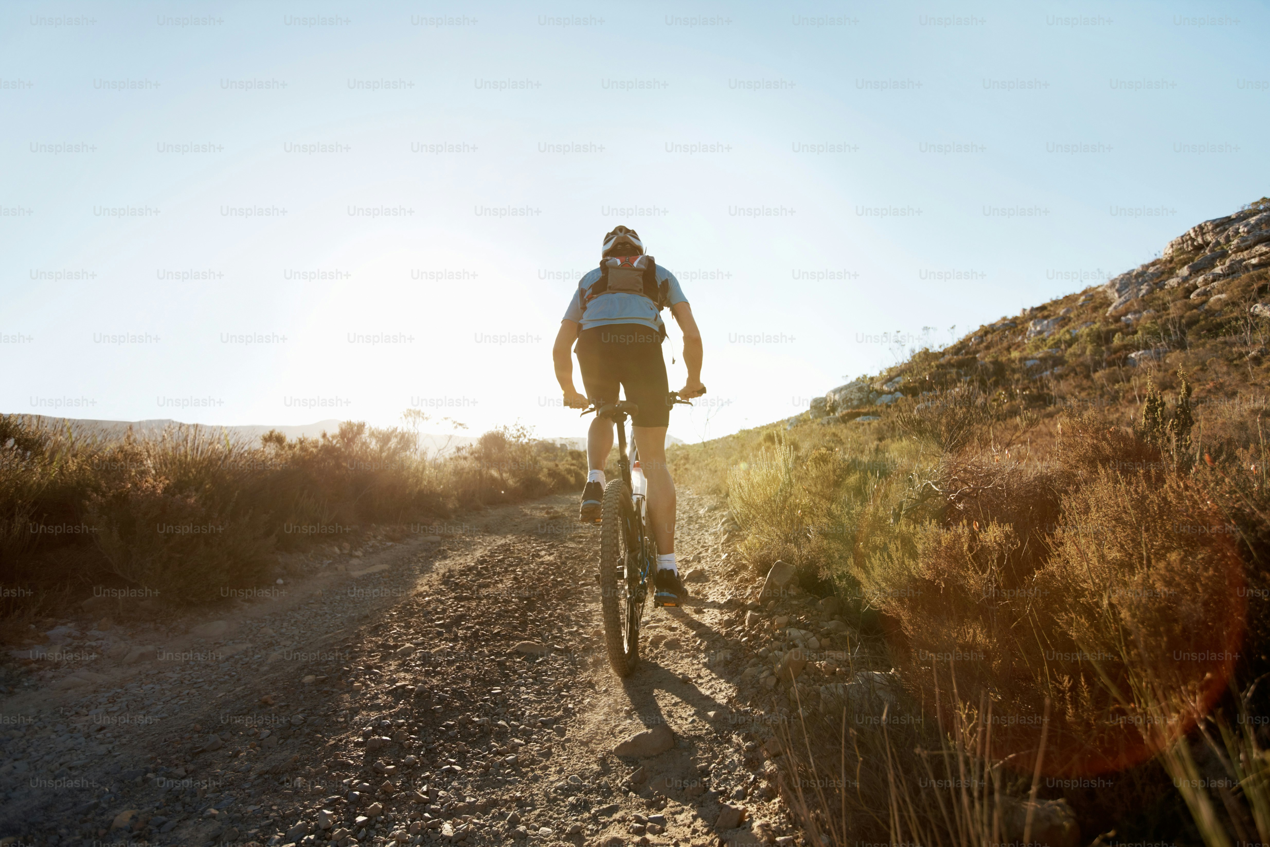 Mountain biker riding on single track trail in the countryside photo ...