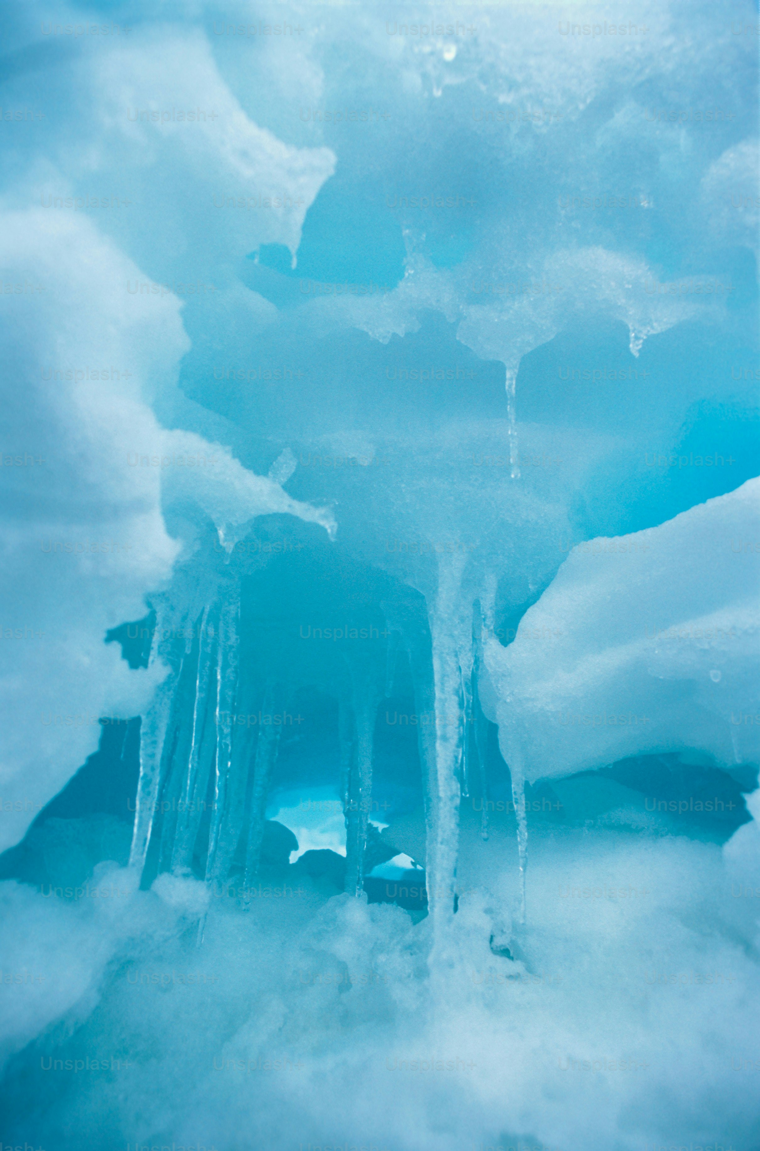 A group of ice formations in the water photo – Ice cave Image on Unsplash