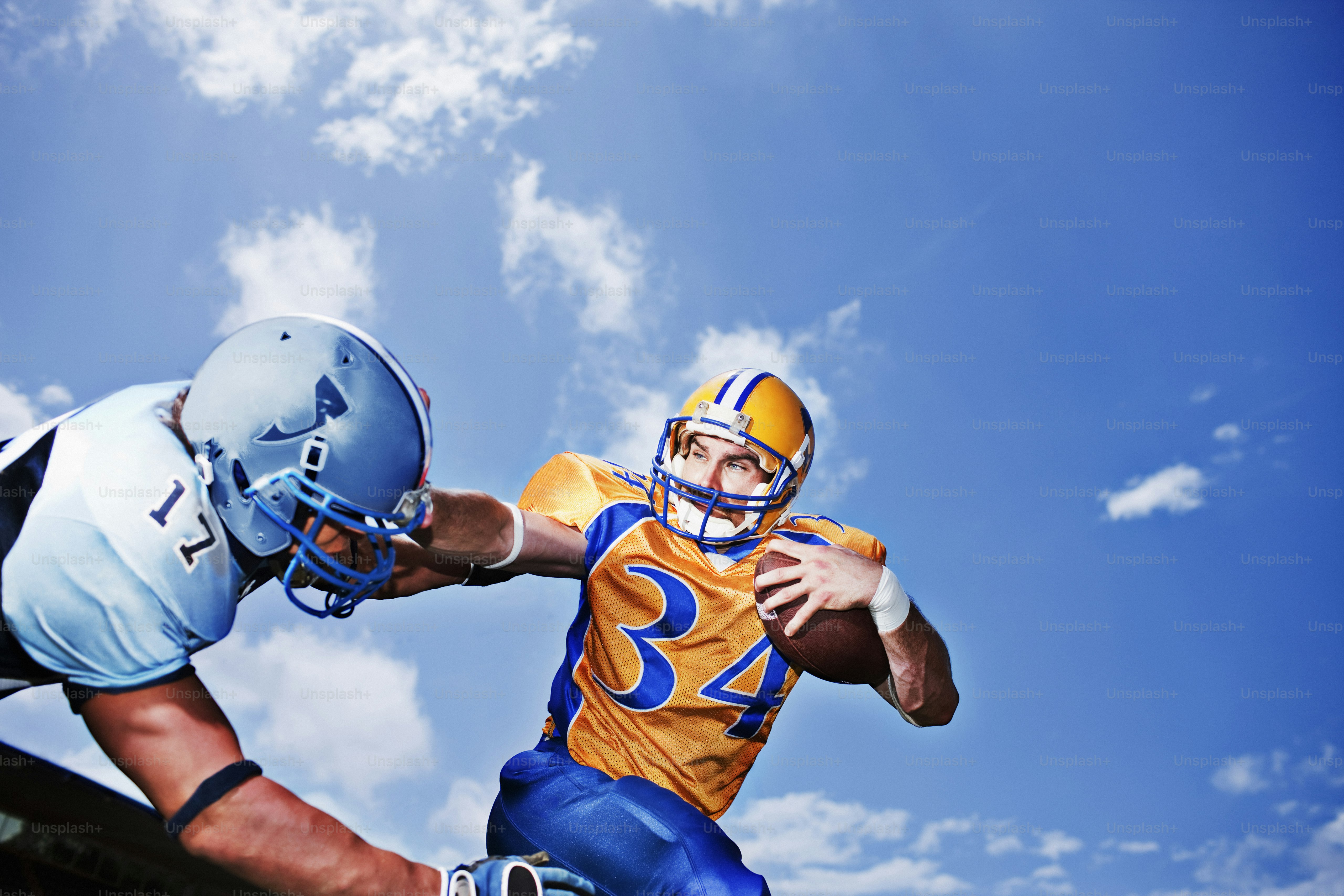 Two football players are playing against each other photo – Day sky ...
