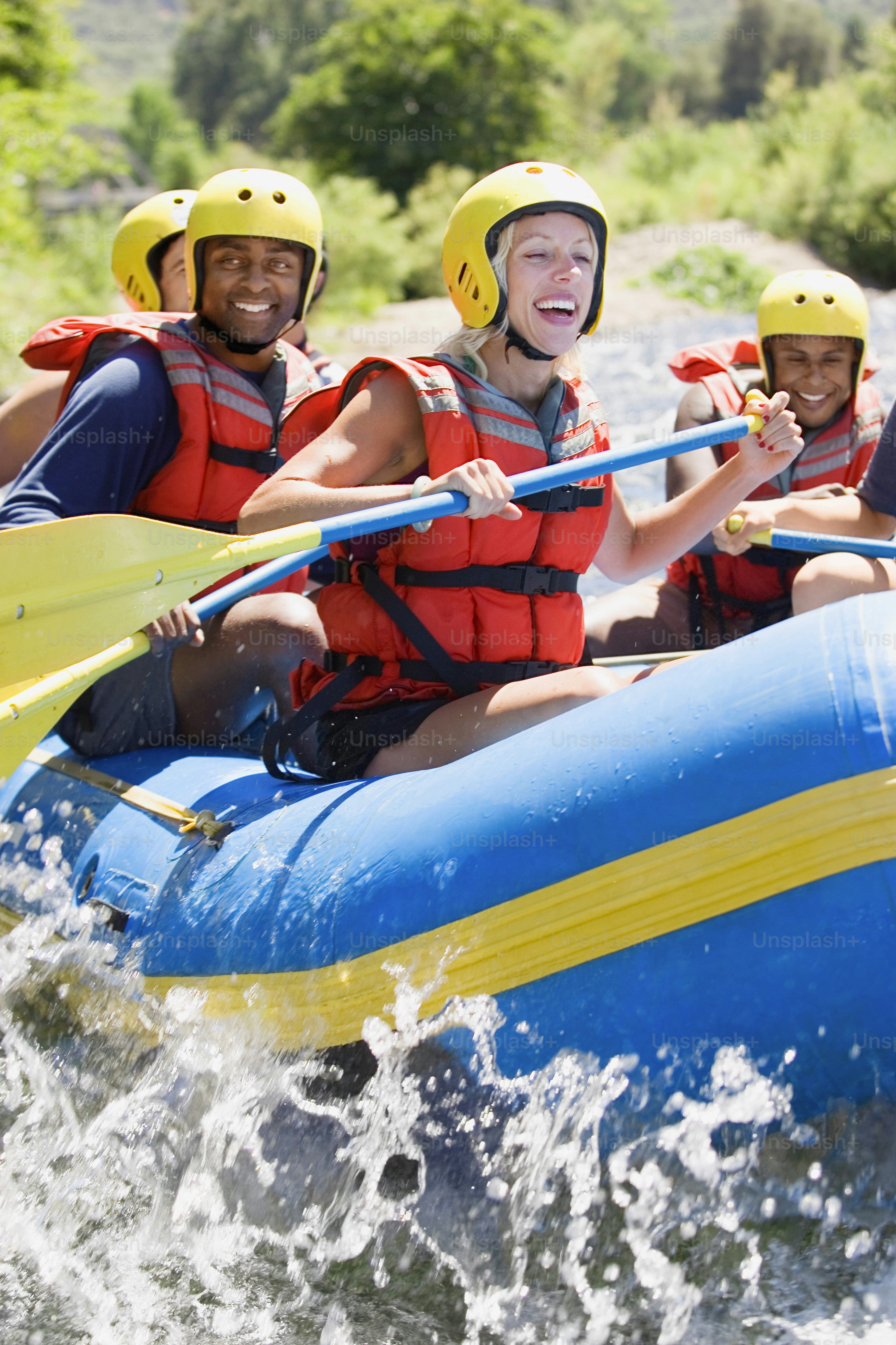 A group of people riding a raft down a river photo – Rafting Image on ...