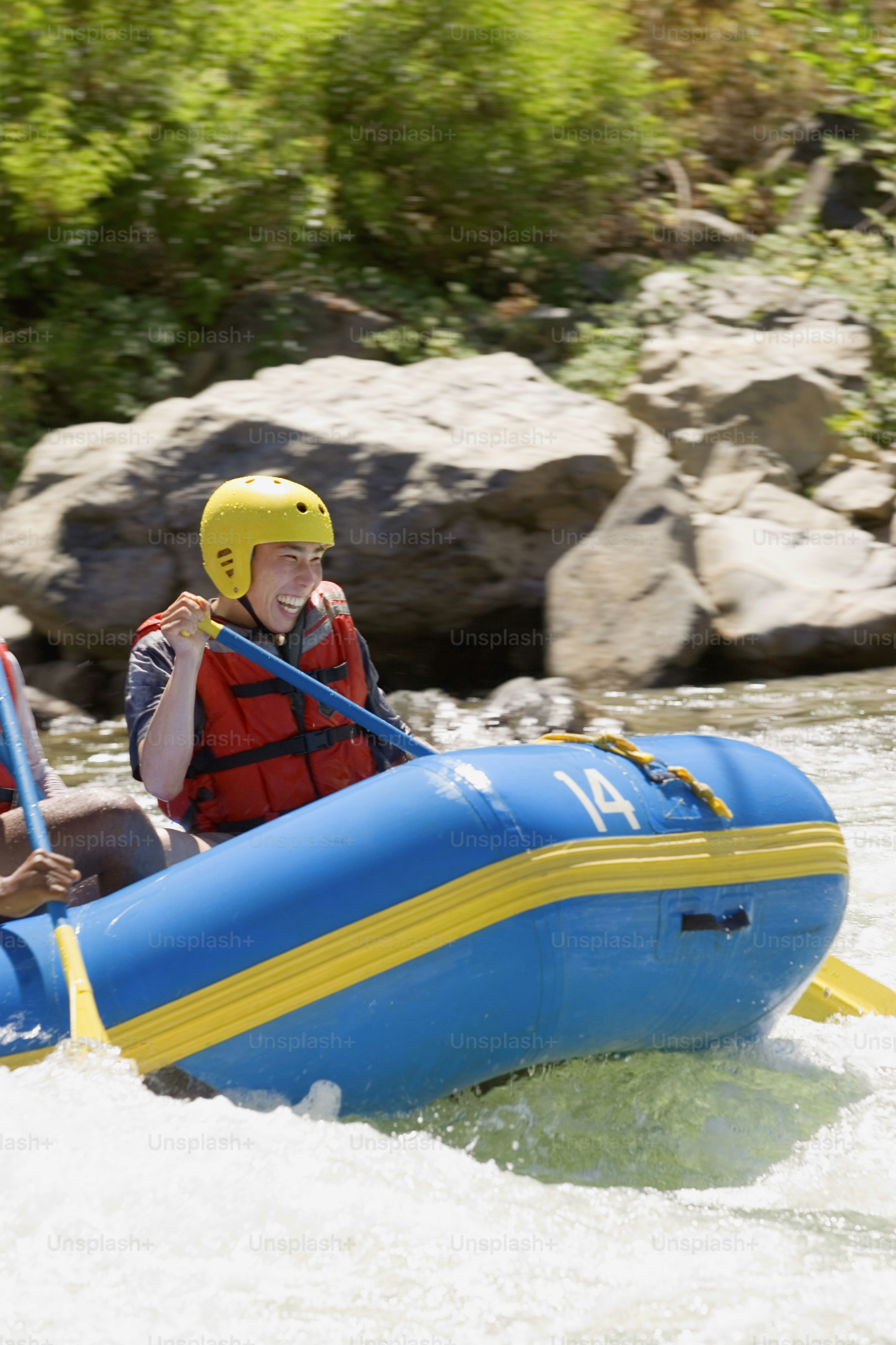 A man riding a raft down a river photo – River rafting Image on Unsplash