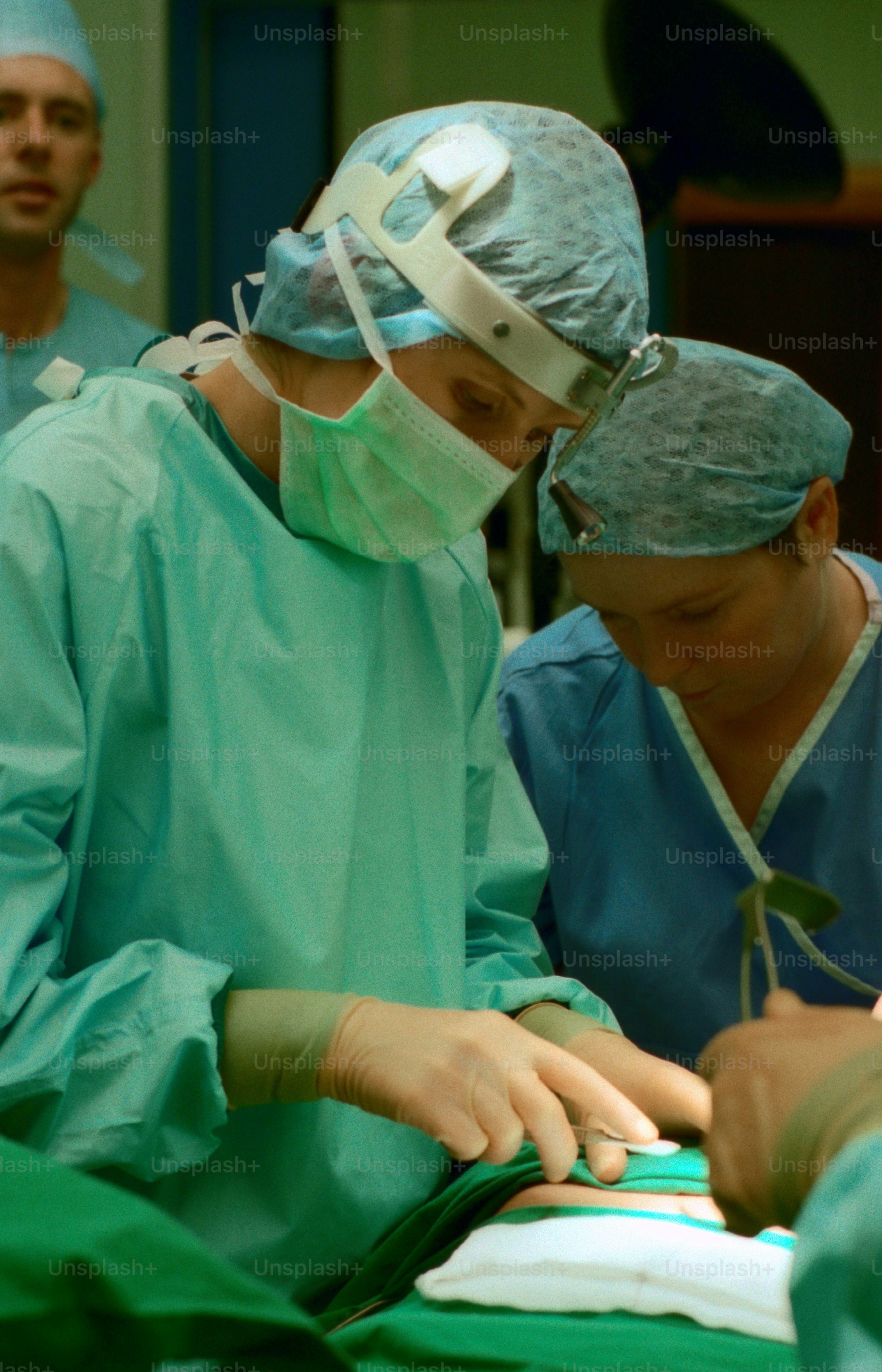 A group of doctors performing surgery in a hospital photo – Hospital ...
