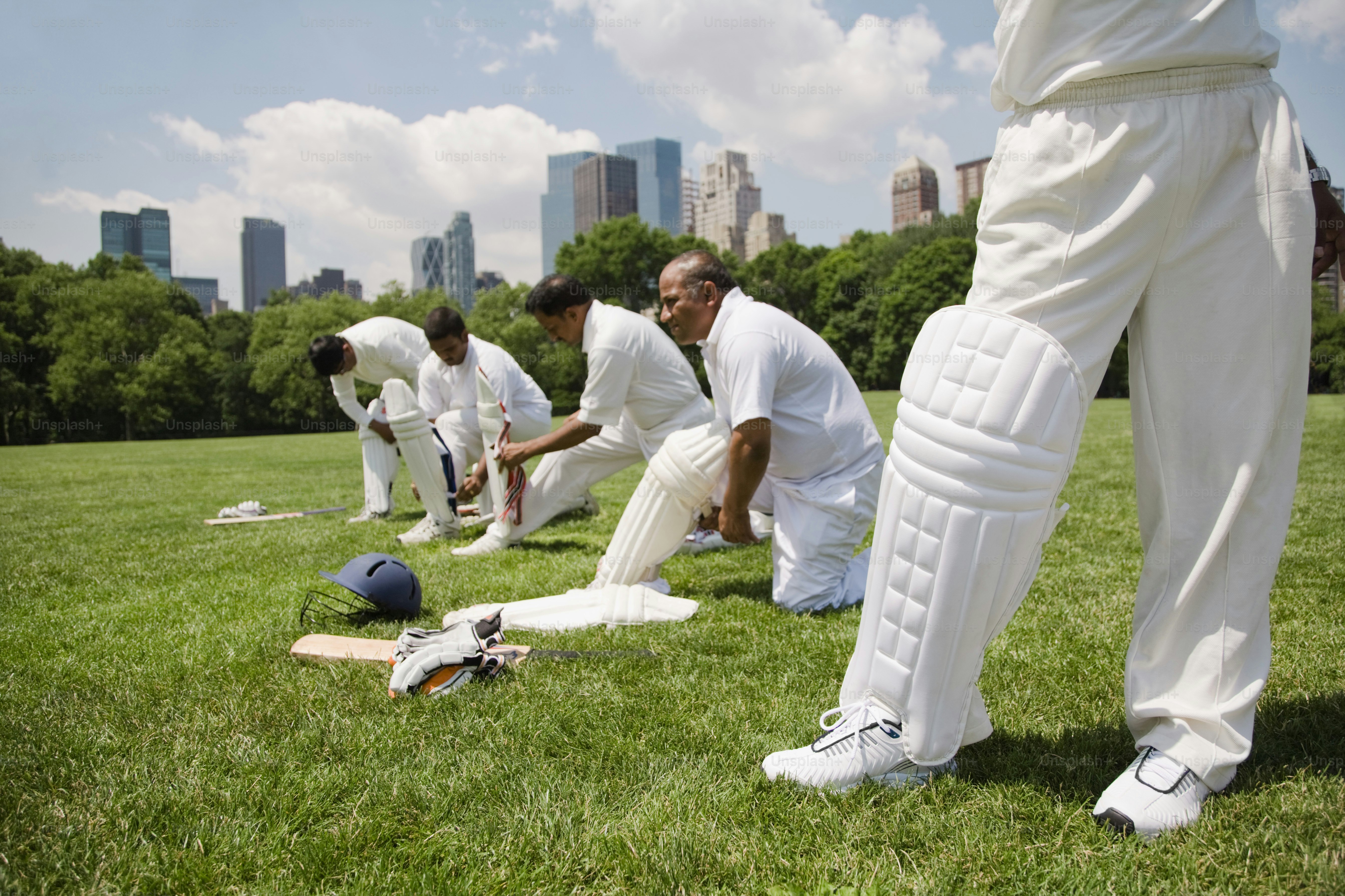 A group of men playing a game of cricket photo – Adult Image on Unsplash