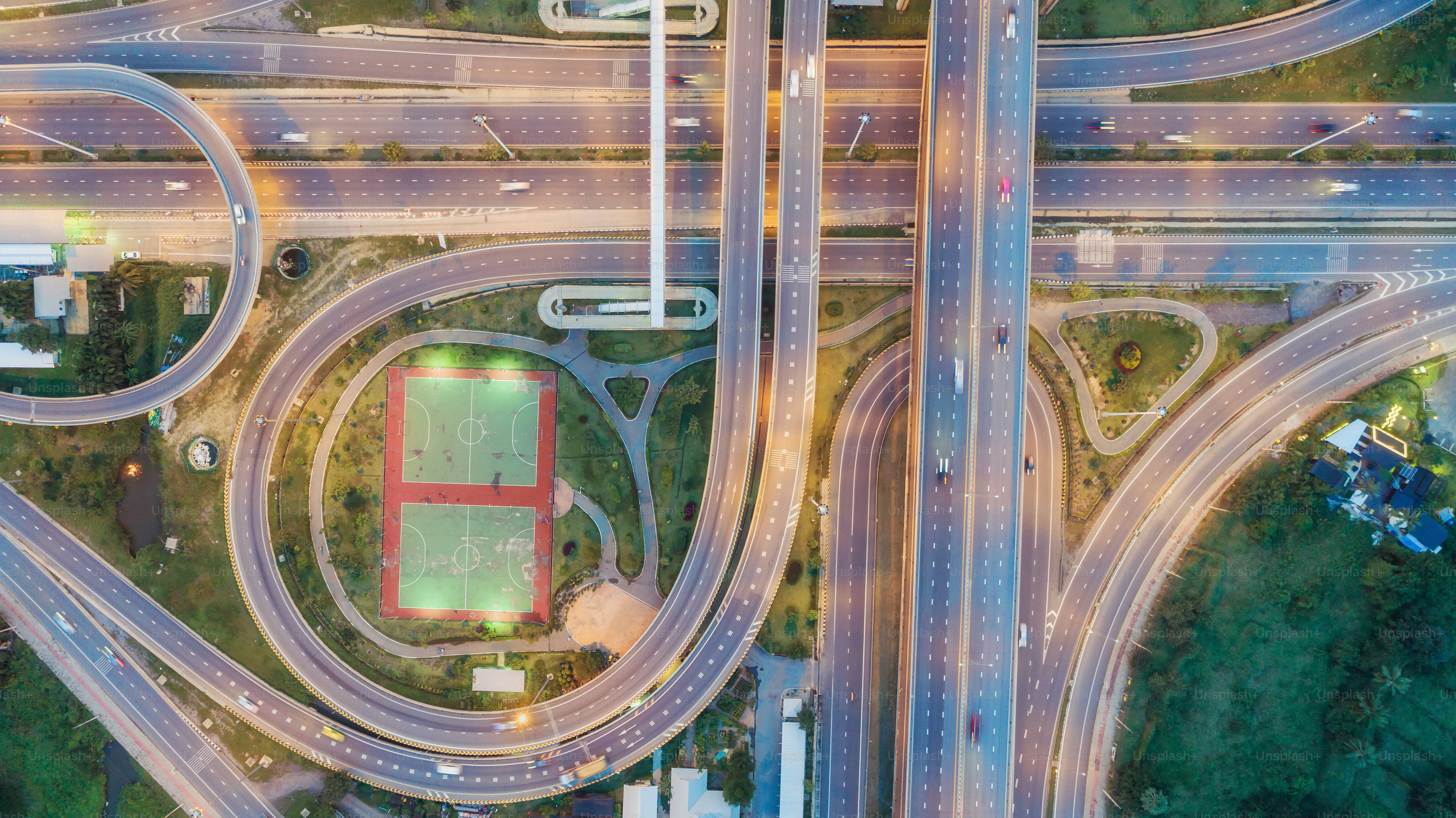 Aerial view highway road intersection and circle at dusk for ...