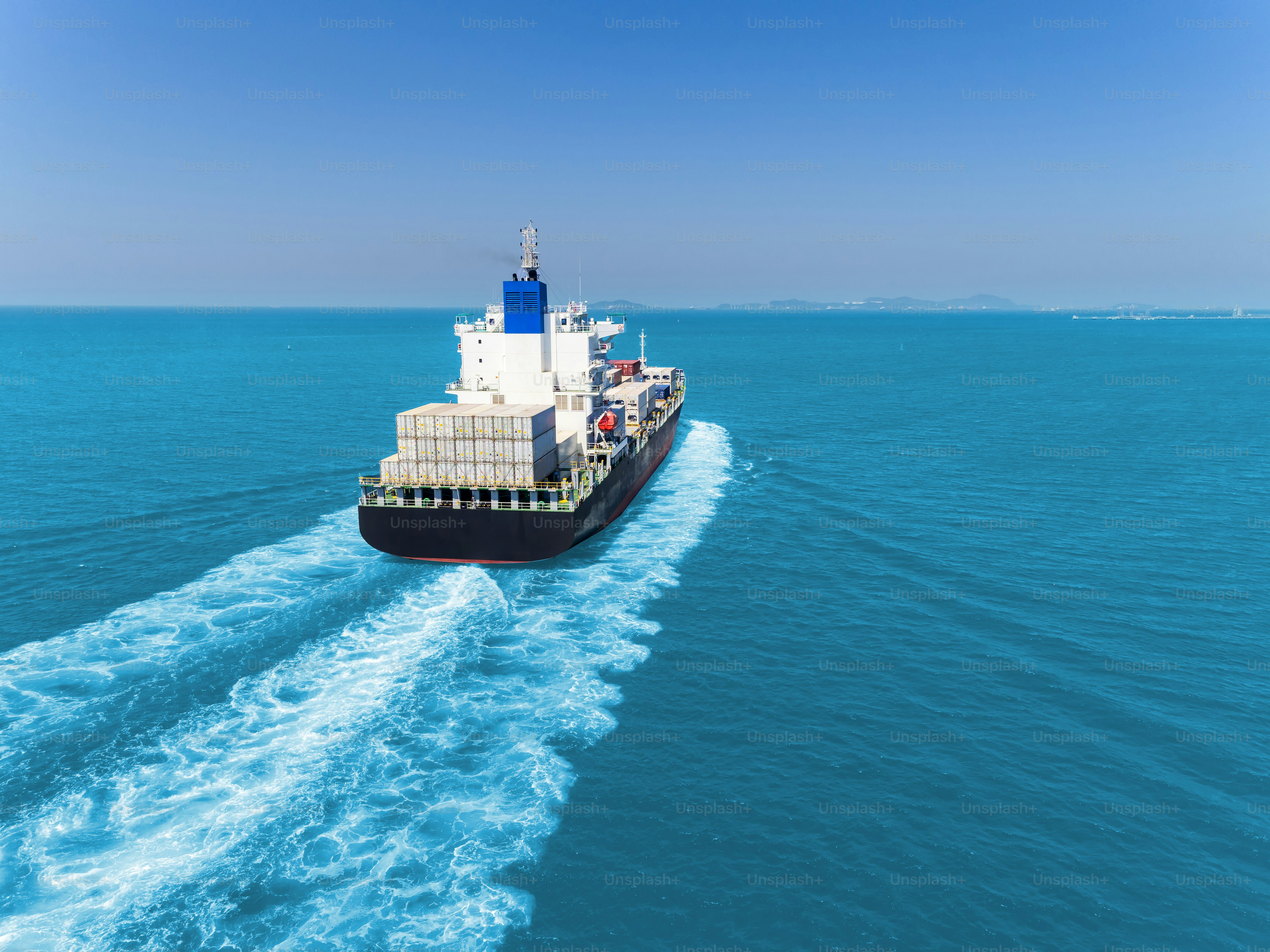 Aerial view Tug boats drag container ship to sea port for unloading ...