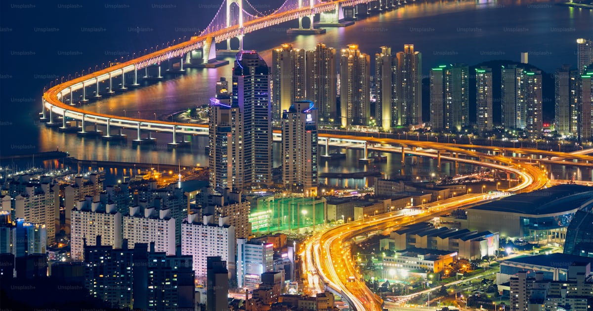고층 빌딩이 있는 부산 도심과 광안대교가 야간에 밝게 빛납니다 부산 대한민국 사진 Unsplash의 네온 시티 이미지