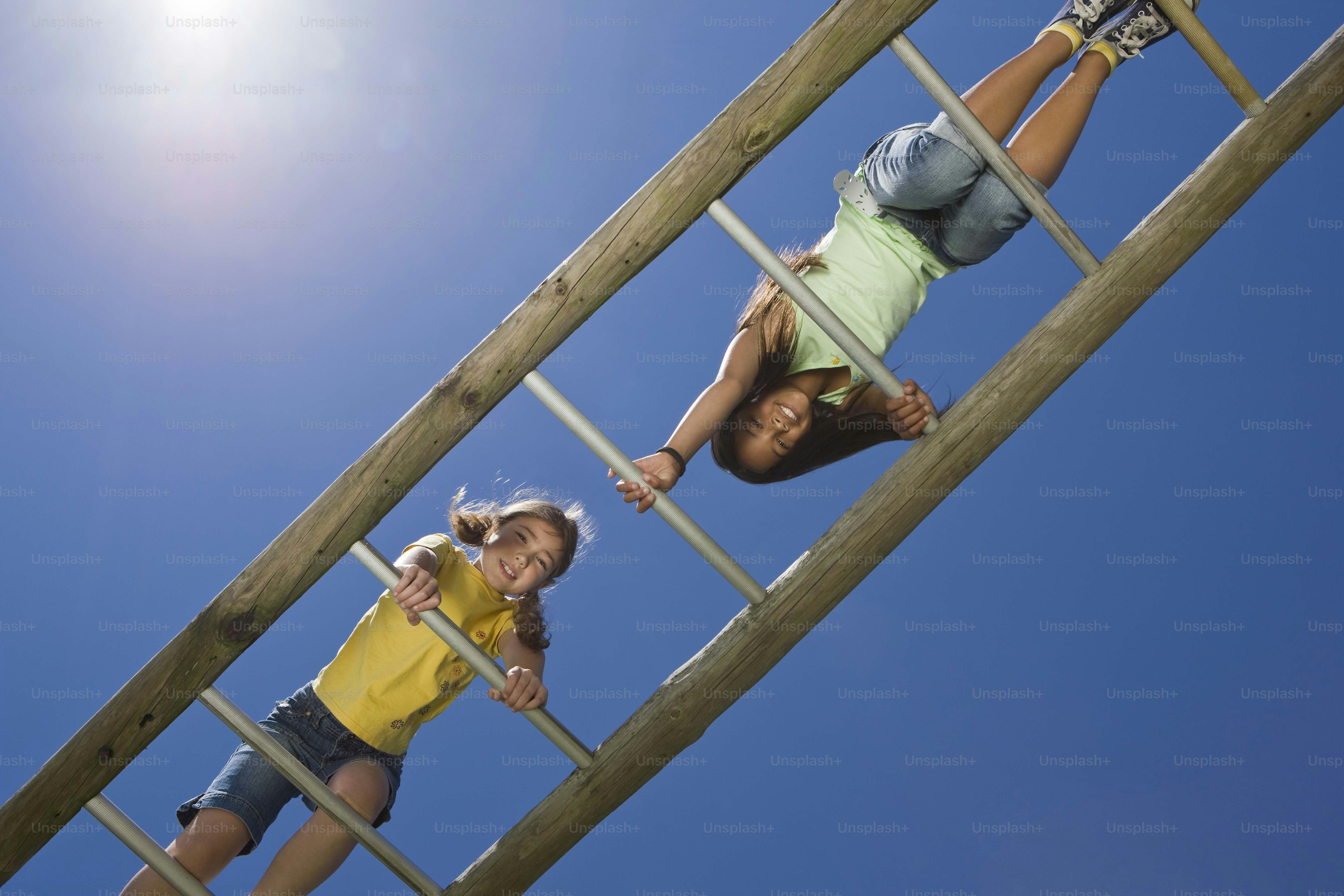 A couple of kids standing on top of a wooden ladder photo – Child Image ...