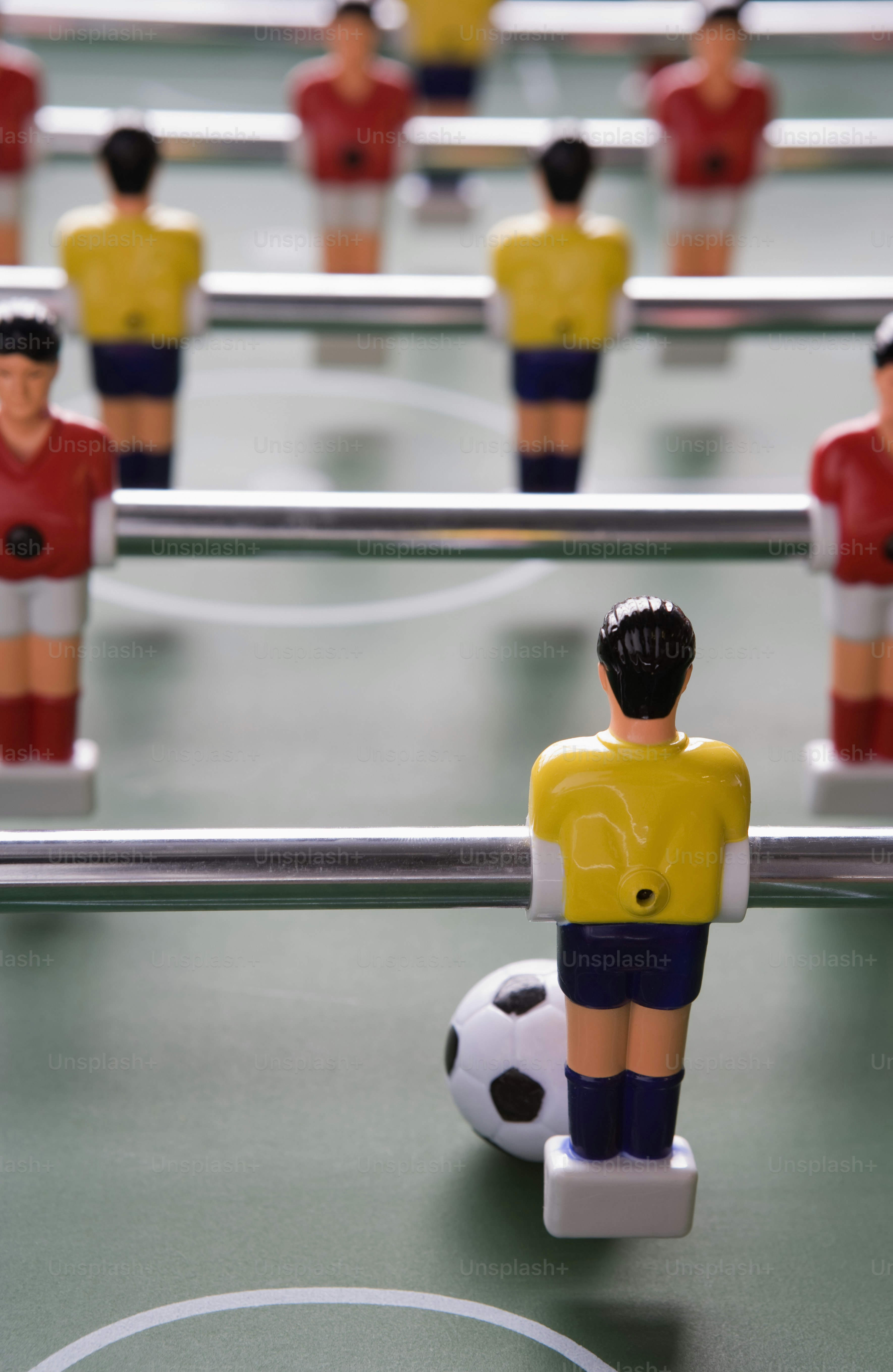 A close up of a foosball table with foosball players photo – Soccer ...
