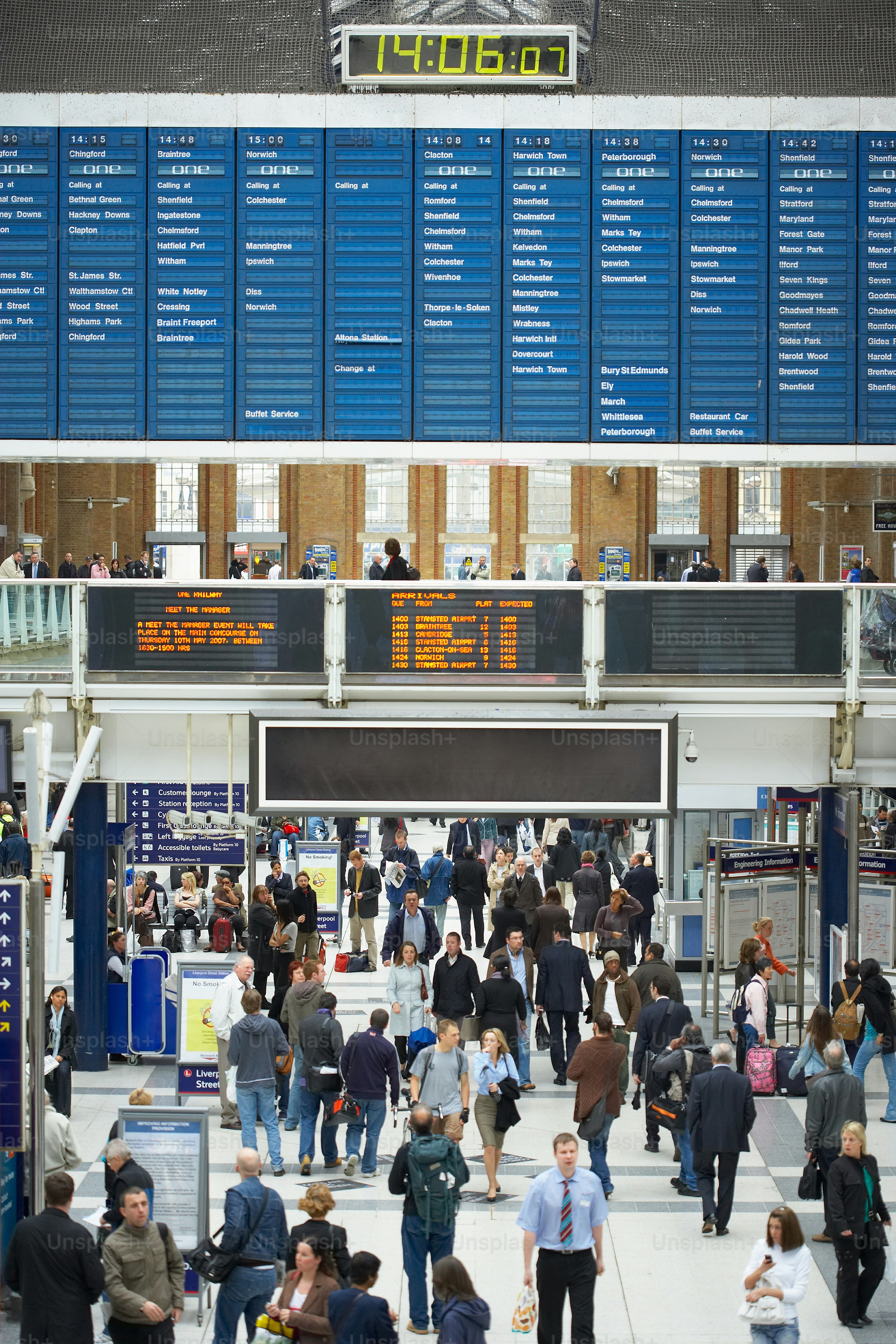 A crowd of people walking through a train station photo – Adult Image ...