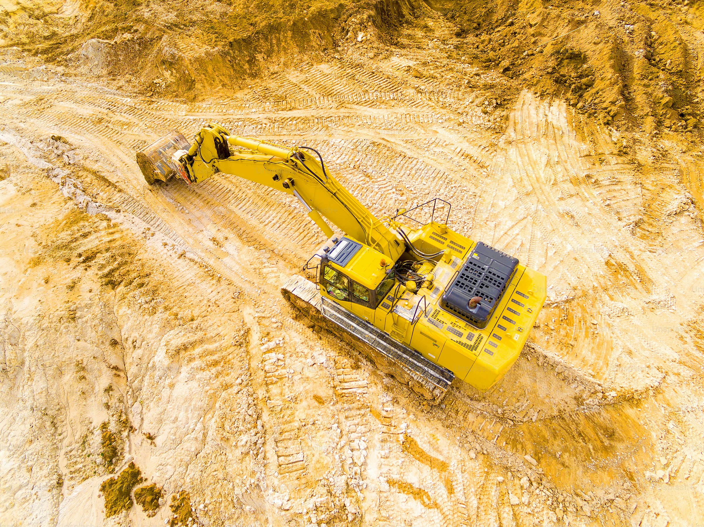 Aerial view of a excavator in open cast mine or on construction site ...