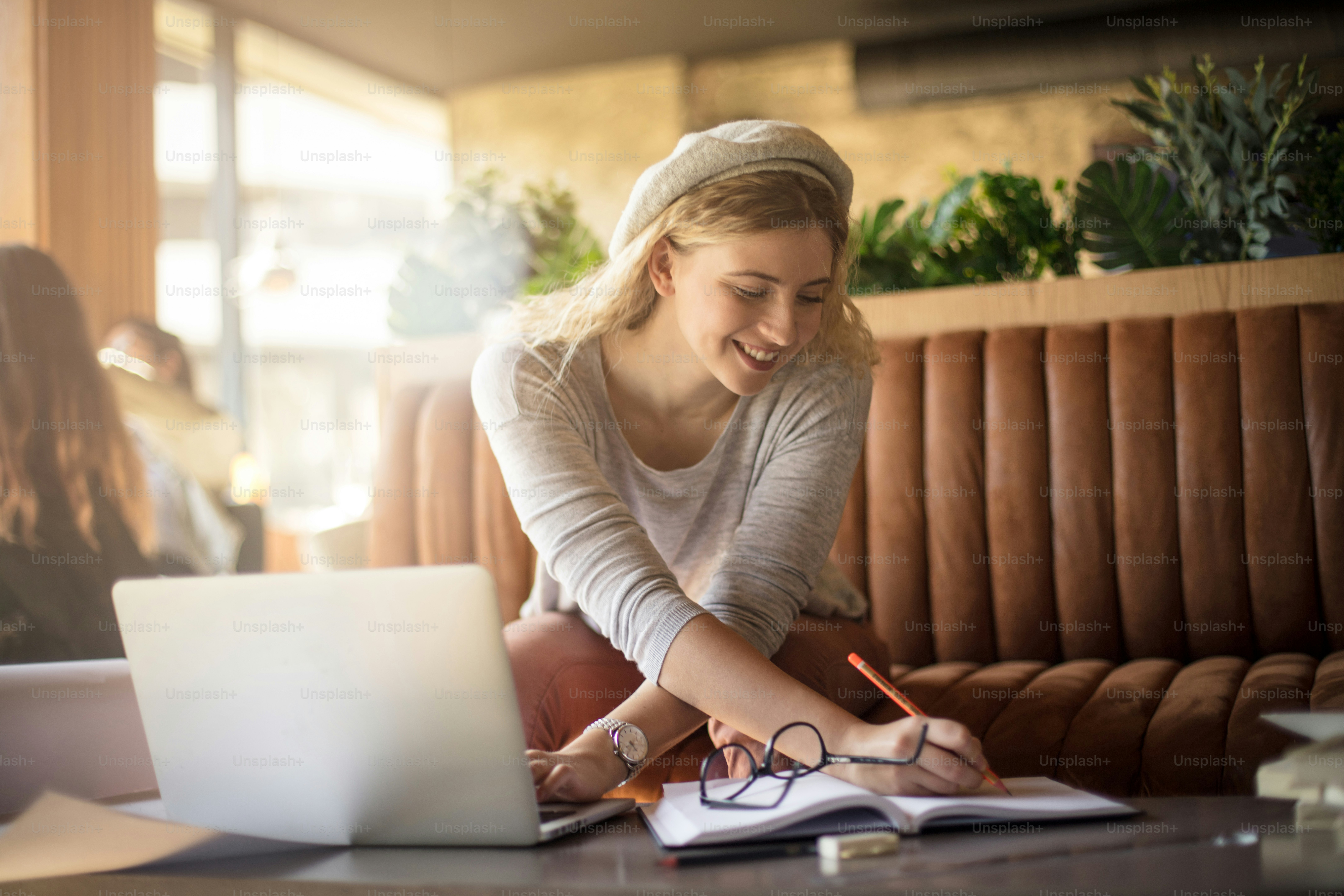 Write down important things from the lesson. Young student girl working ...