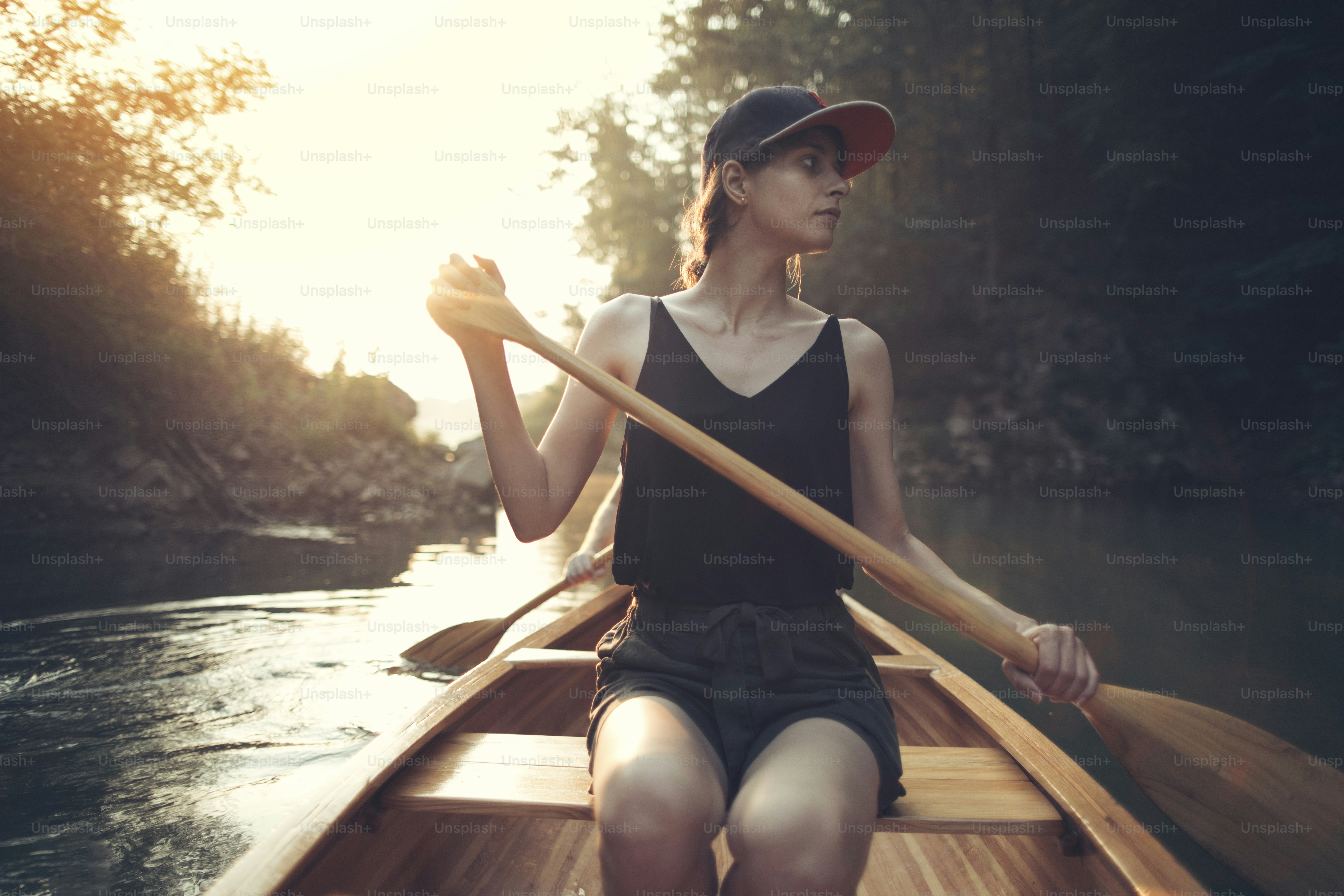 Woman paddling canoe on a forest lake, copy space. photo – Relaxation ...