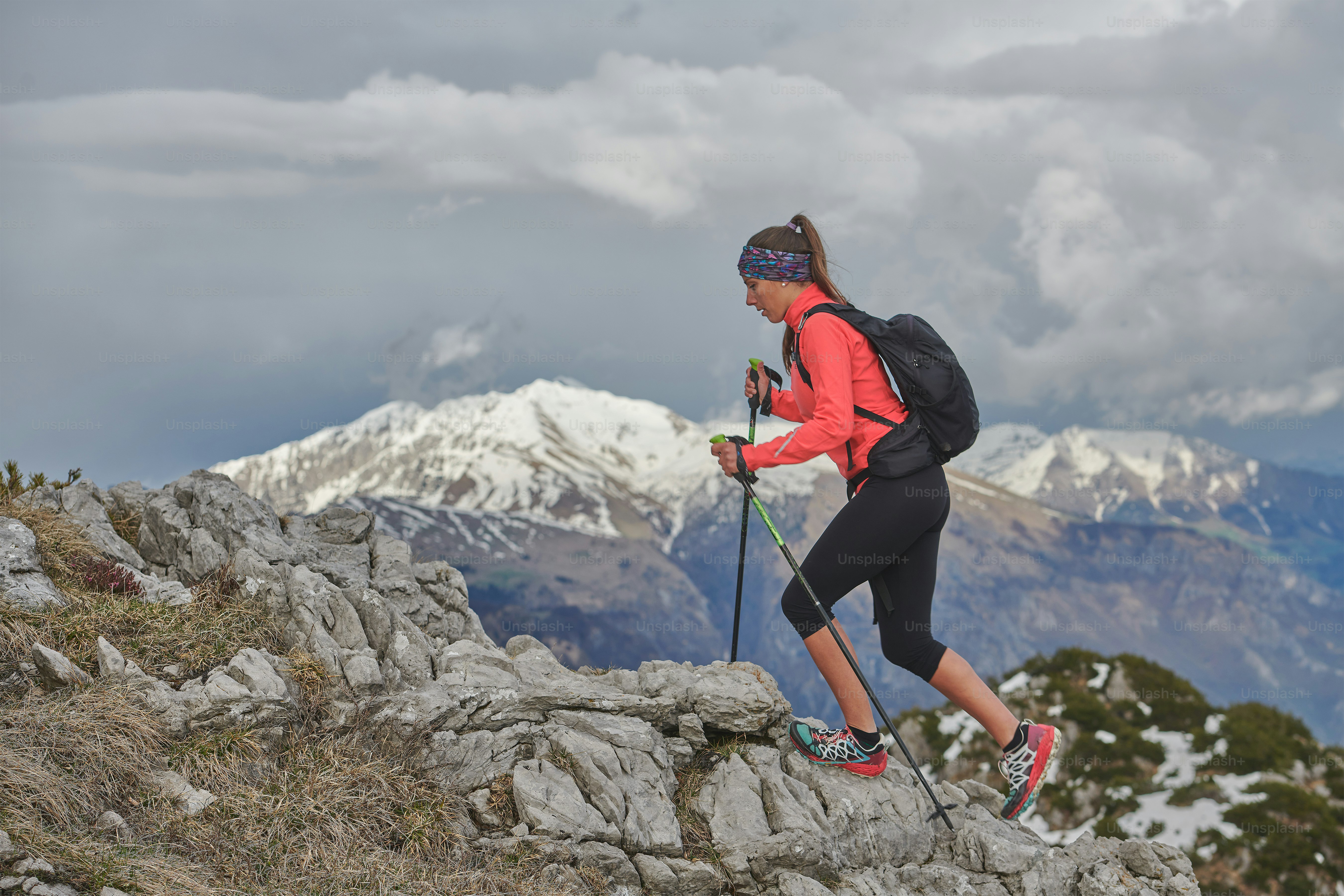 Woman during an alpine trek with sticks poles photo – Nature Image on ...