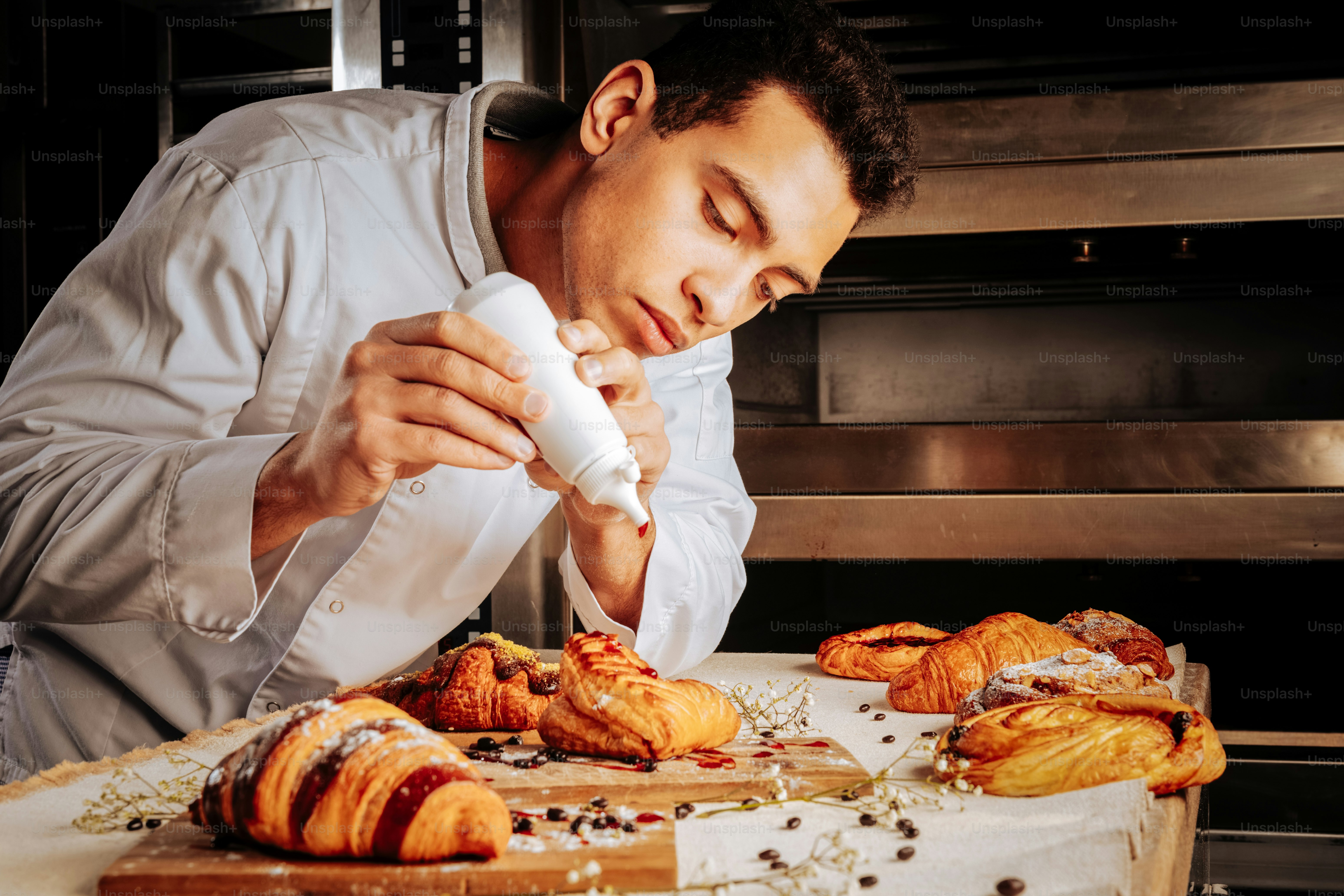 With strawberry jam. Famous talented baker topping croissants and puffs ...