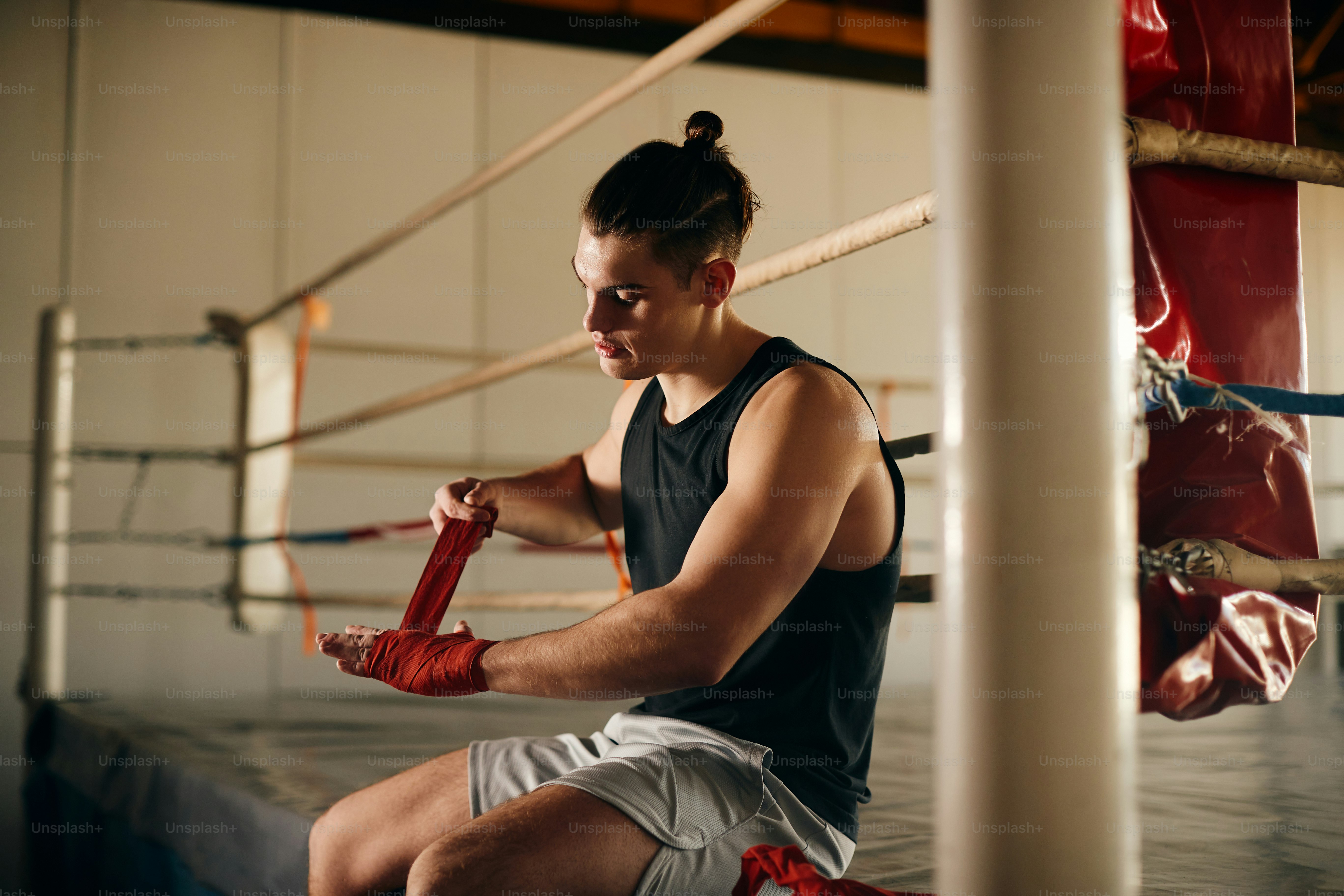 Male boxer getting ready for training and wrapping fists with boxing ...