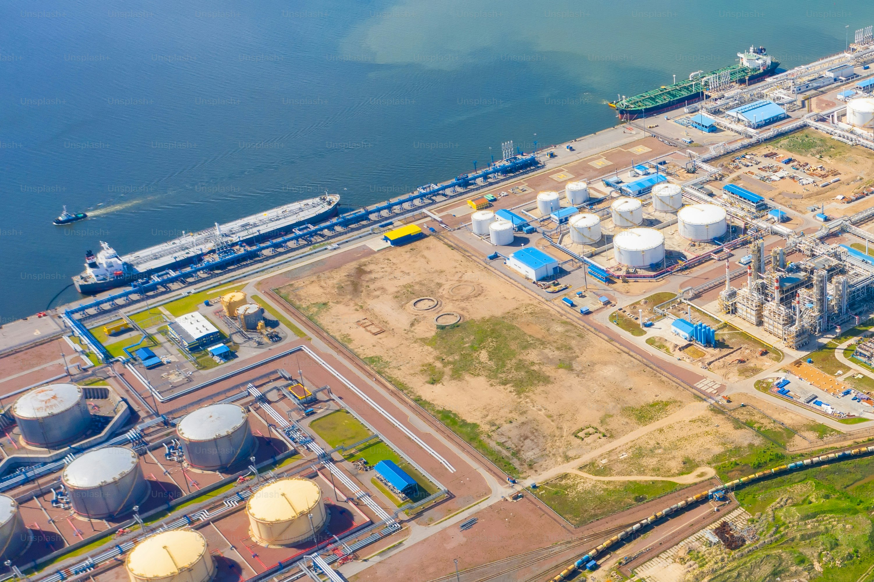 Huge port with oil tanks for storing liquid fuel on the seashore photo ...
