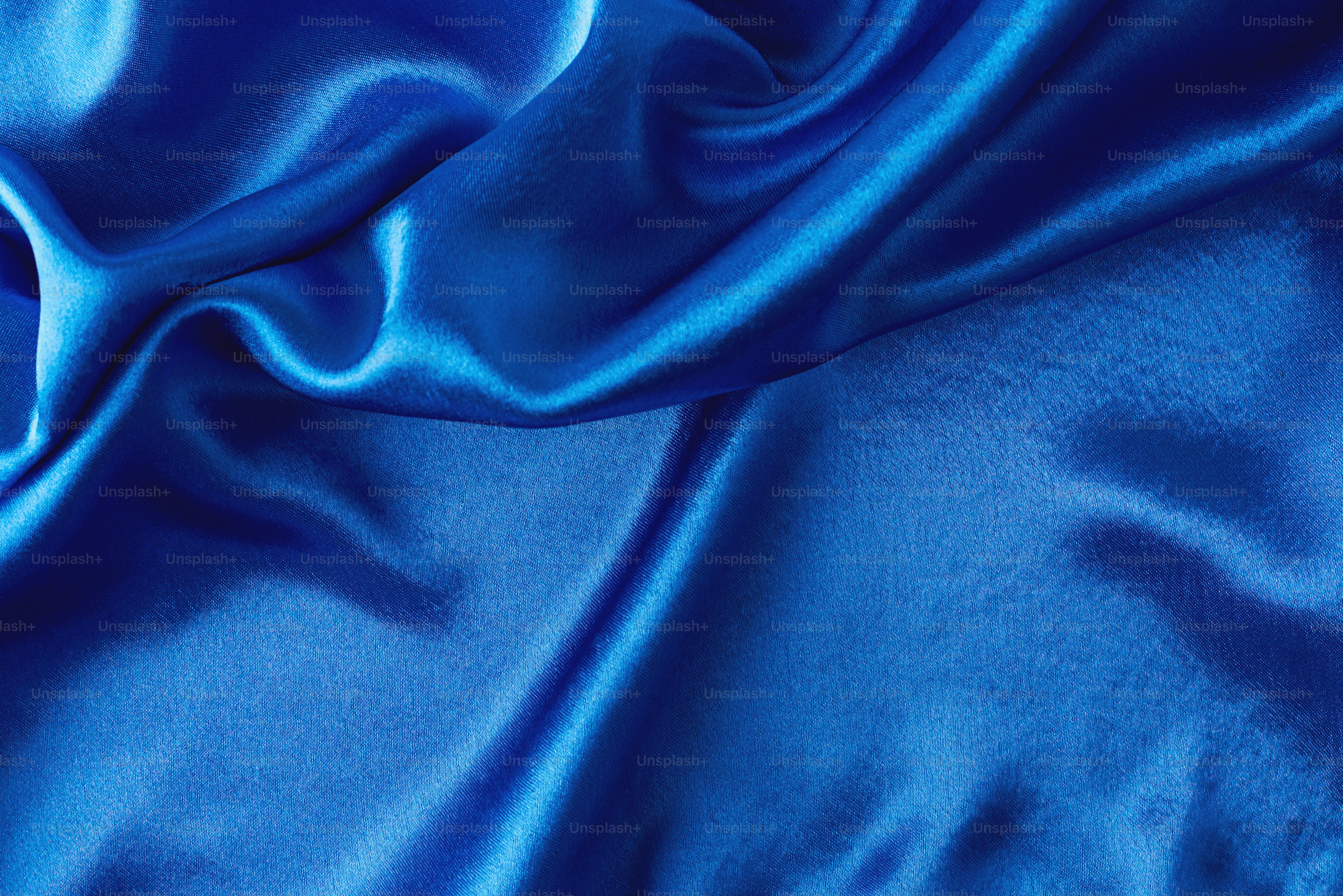 Blue silk background with folds. Abstract texture of rippled satin ...