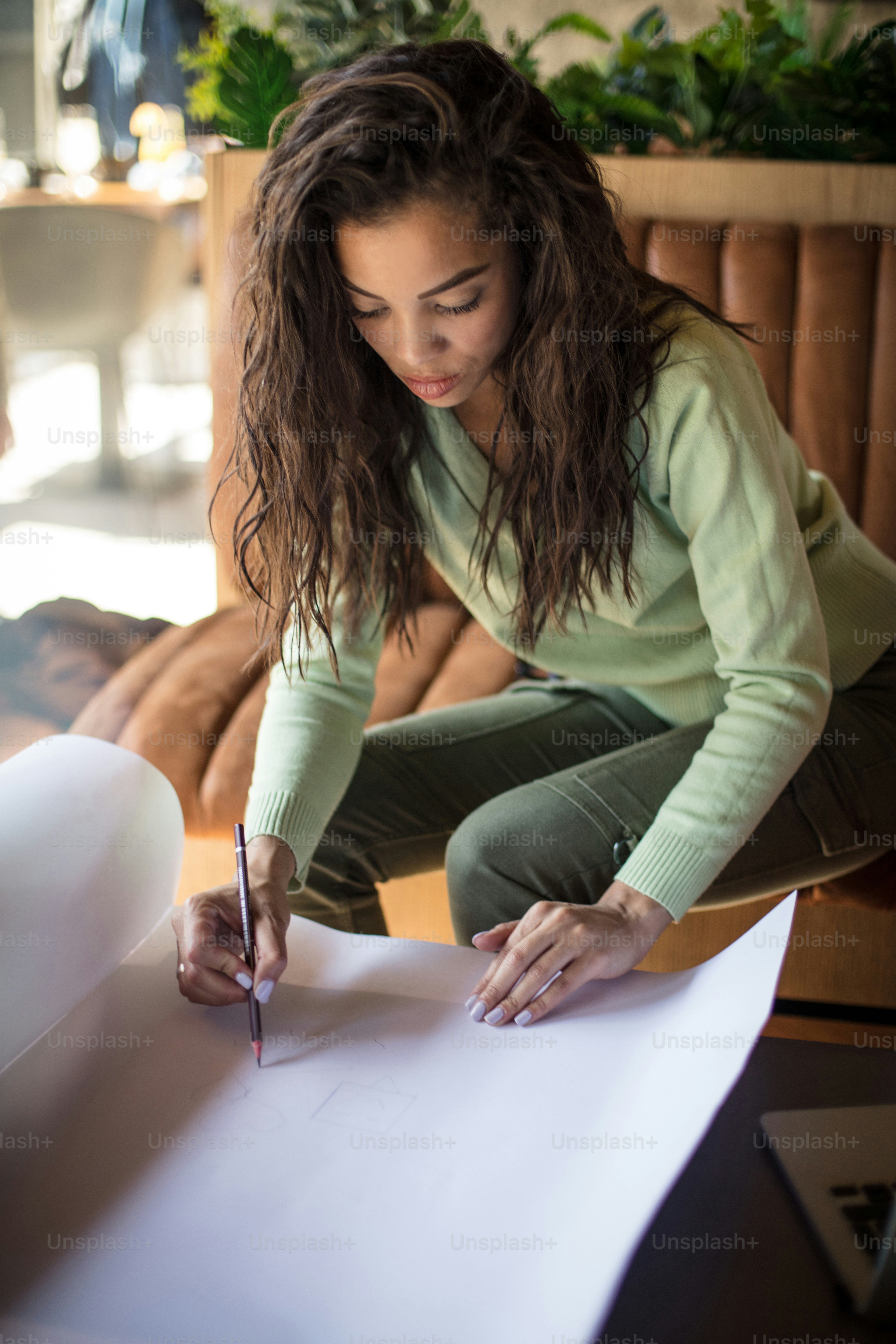 It's important to be persistent. Young student girl at cafe working on ...