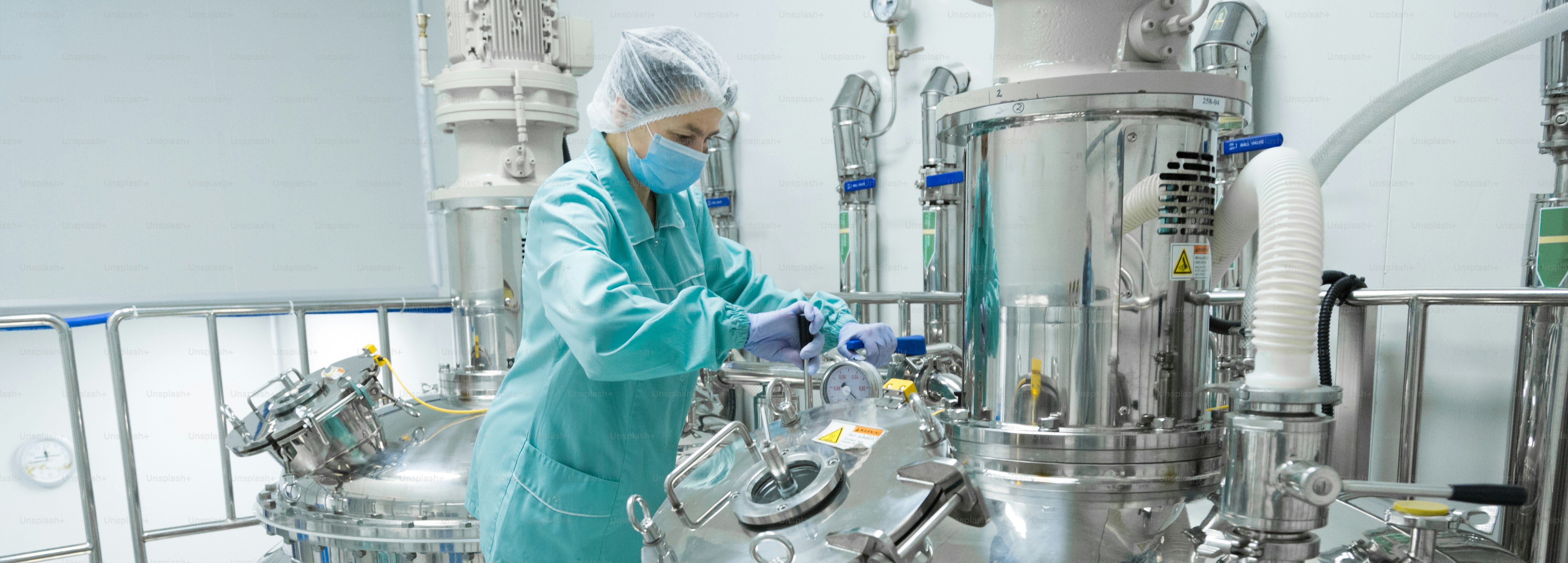 Pharmaceutical technician in sterile environment at pharmacy industry ...