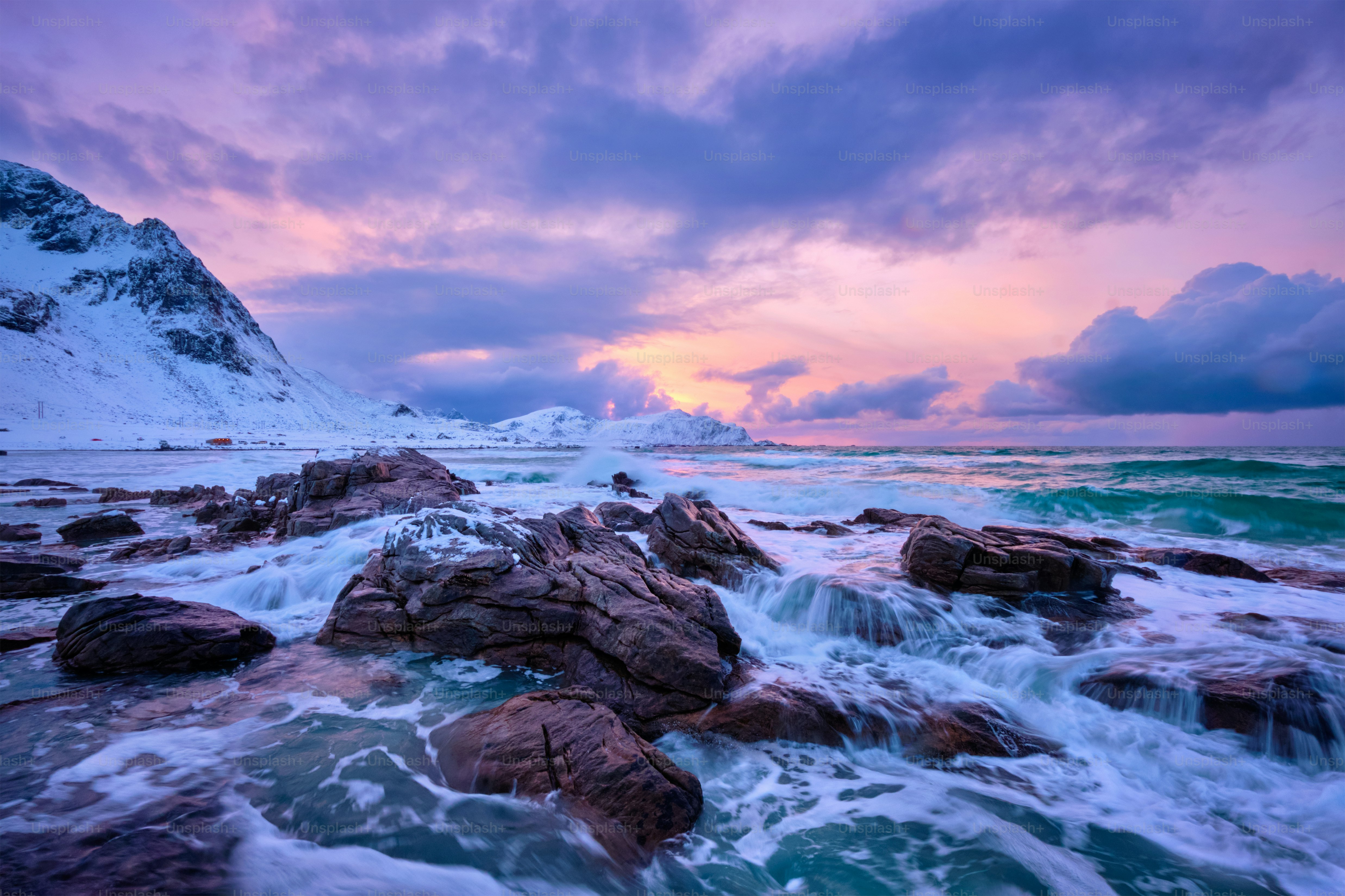 Waves of Norwegian sea on rocky coast in fjord on sunset. Skagsanden ...