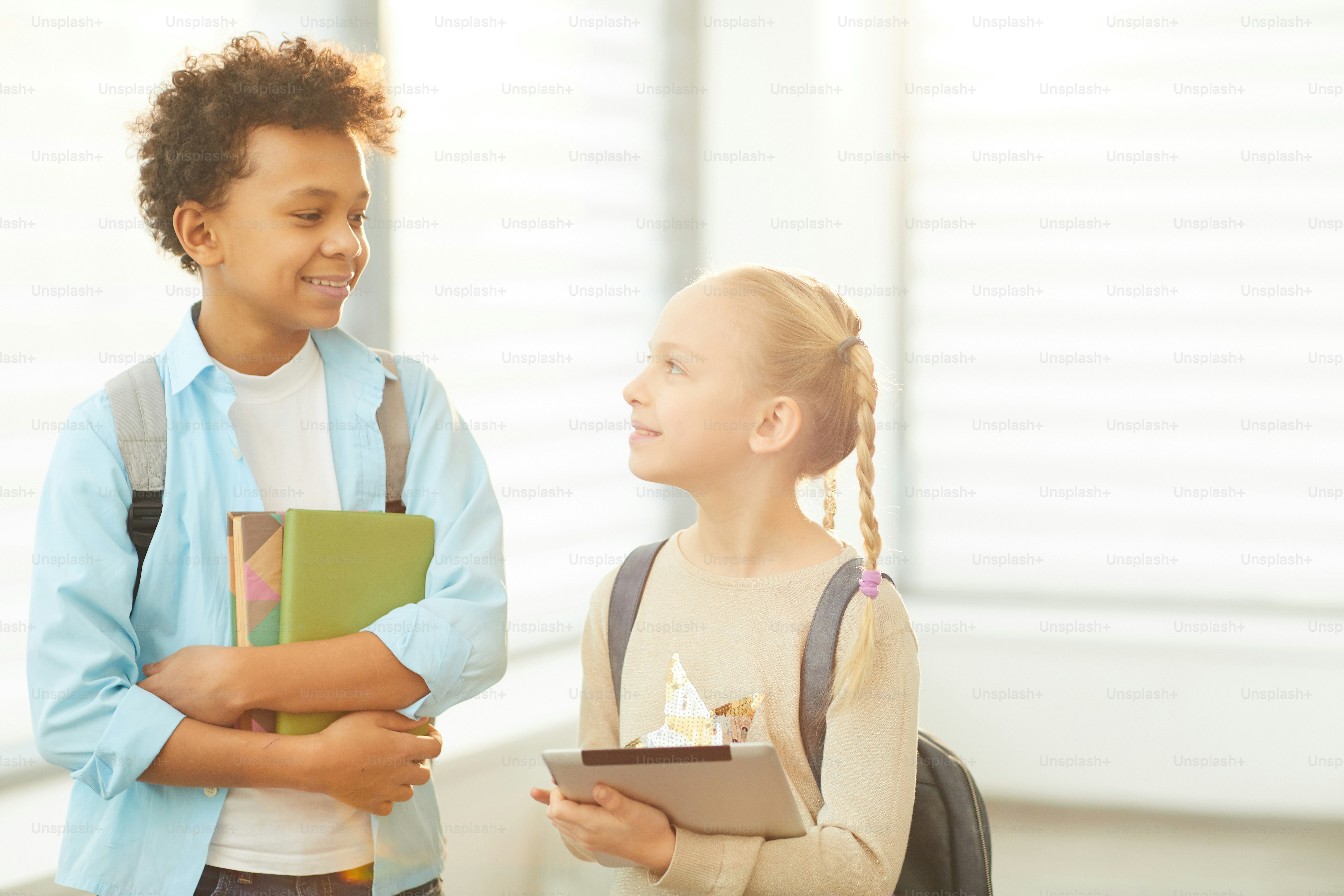 Horizontal medium portrait two classmates standing in school corridor ...