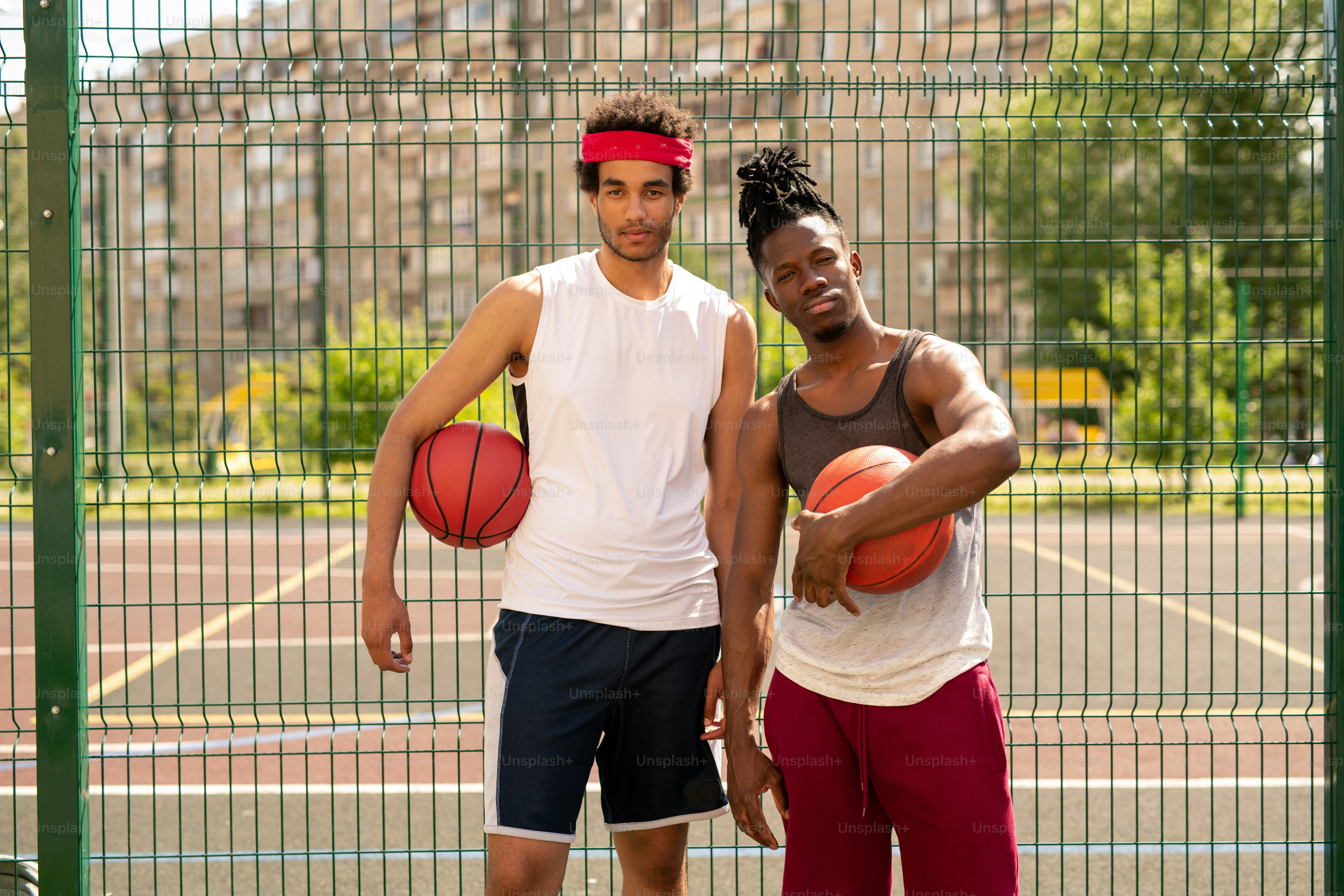 Small group of two young professional basketballers in activewear ...