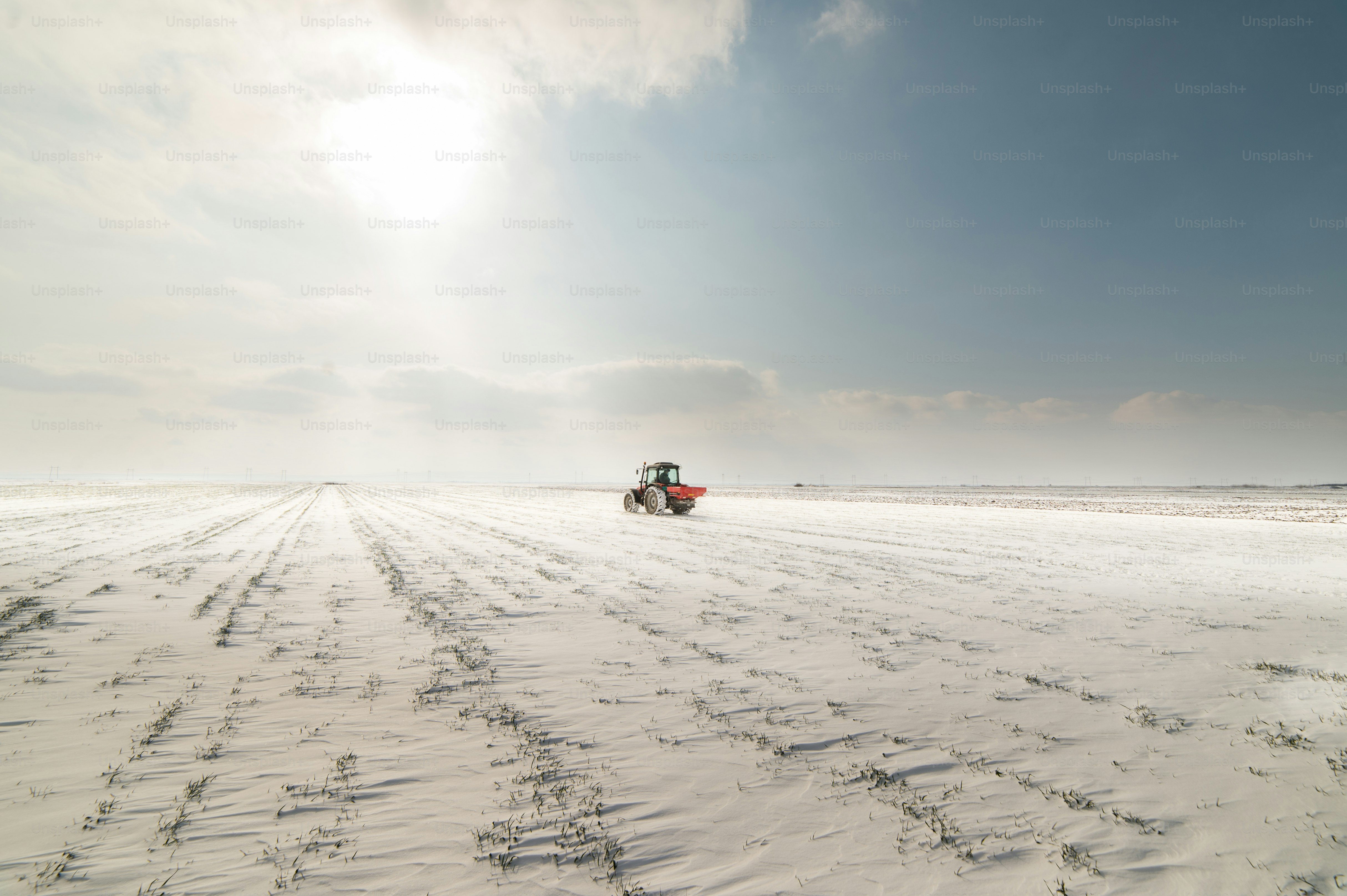 Farmer with tractor seeding - sowing crops at agricultural fields in ...