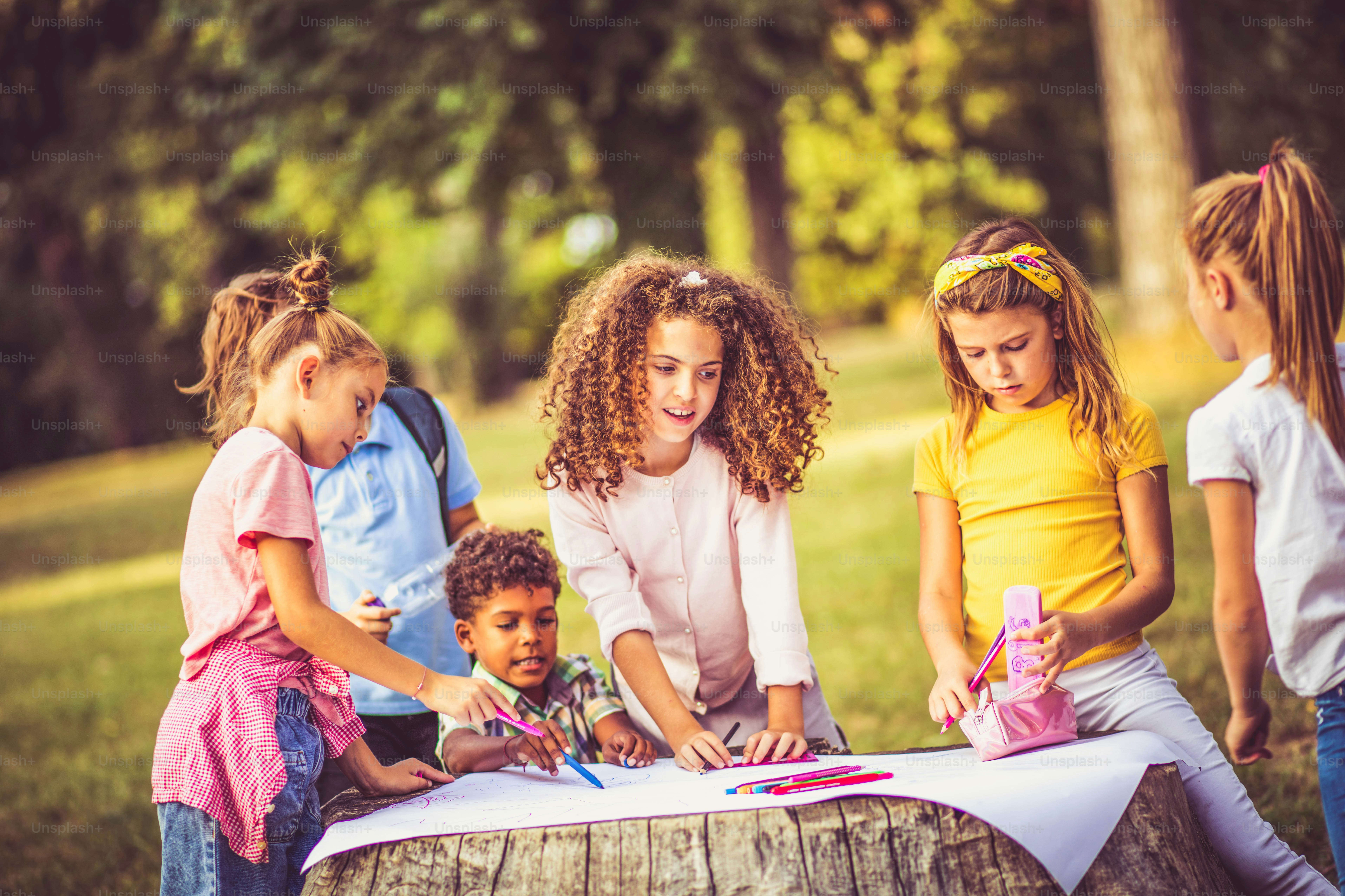 Play time in nature. Large group of school kids having fun in nature ...