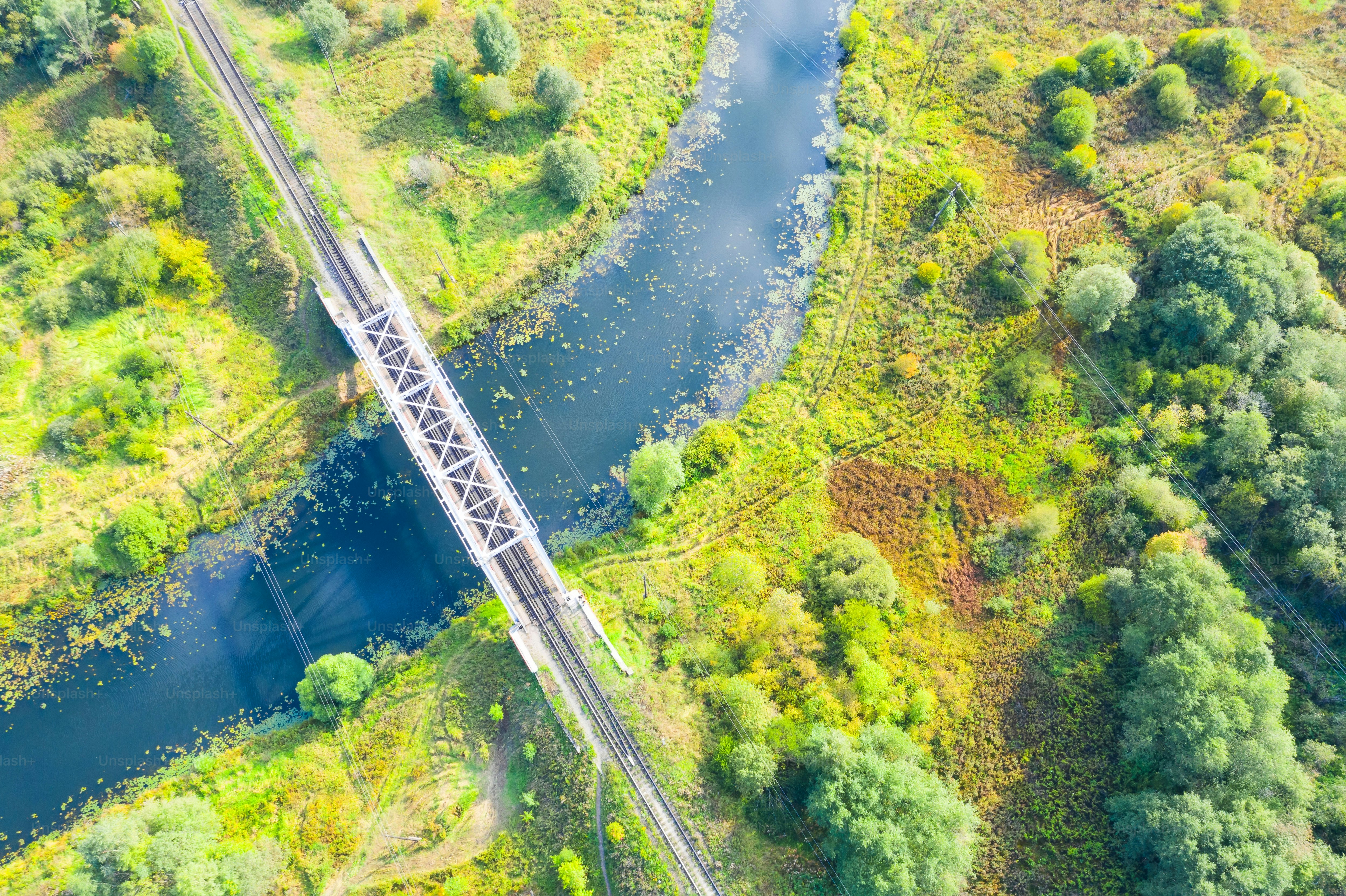Railroad and river bridge in countryside aerial view photo – Canal ...