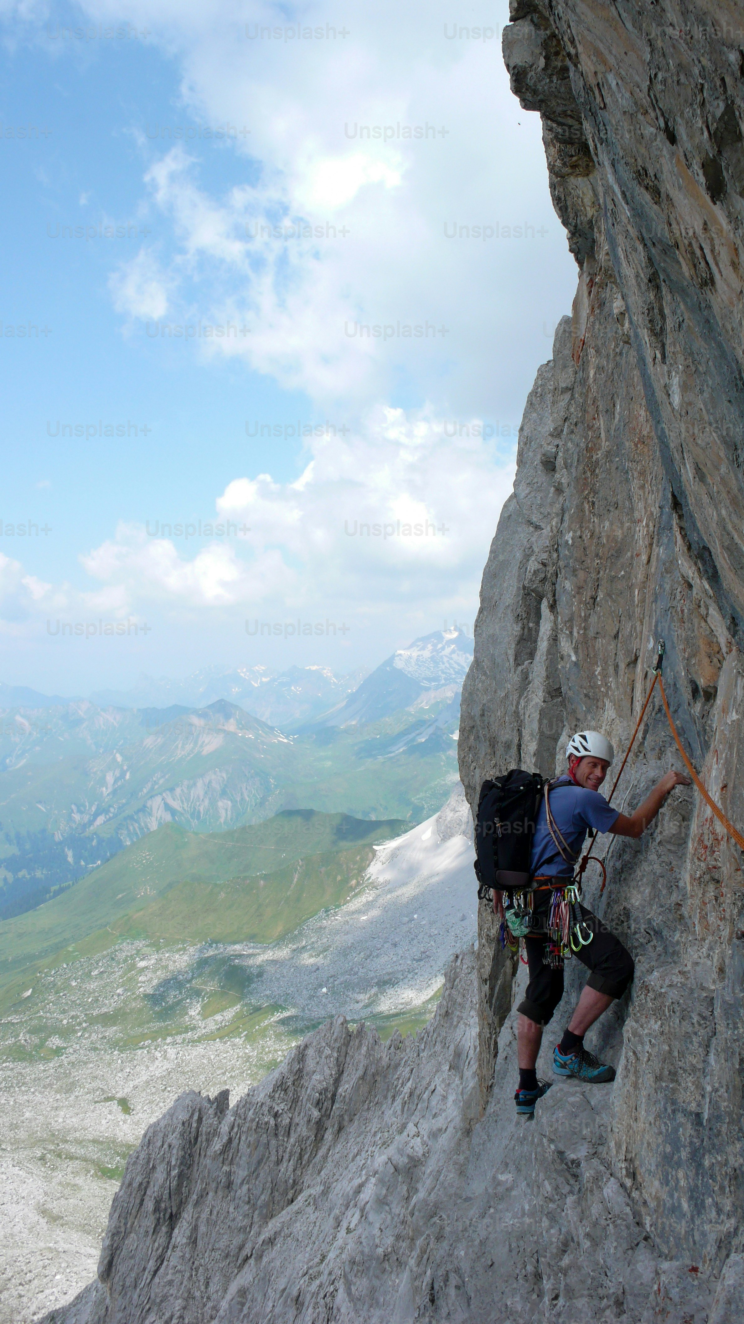 An attractive middle-aged male mountain climber on a steep rock ...