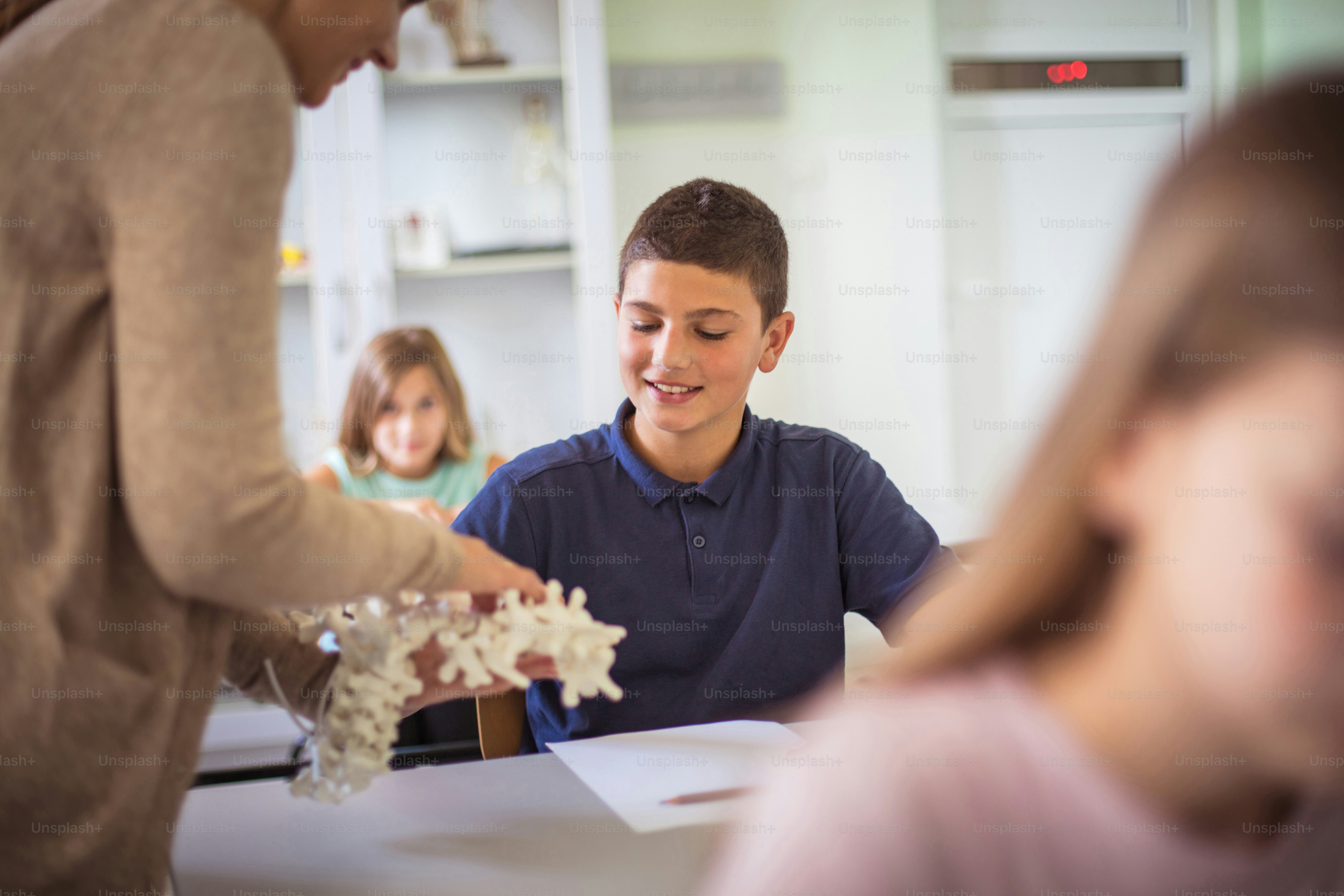 Biology class. Teenage students with teacher on biology class. Close up ...