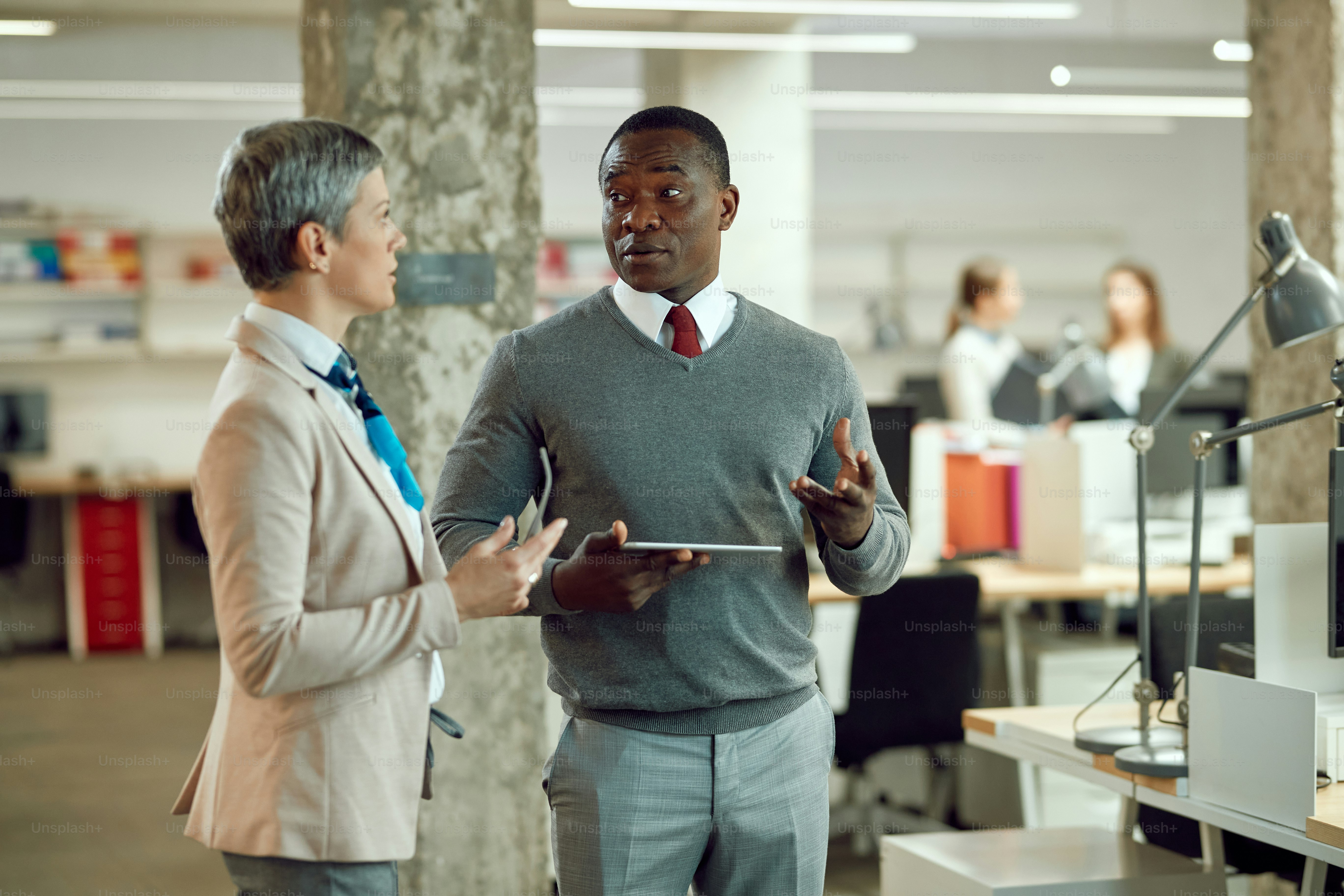Multiracial corporate managers talking on a meeting in the office ...
