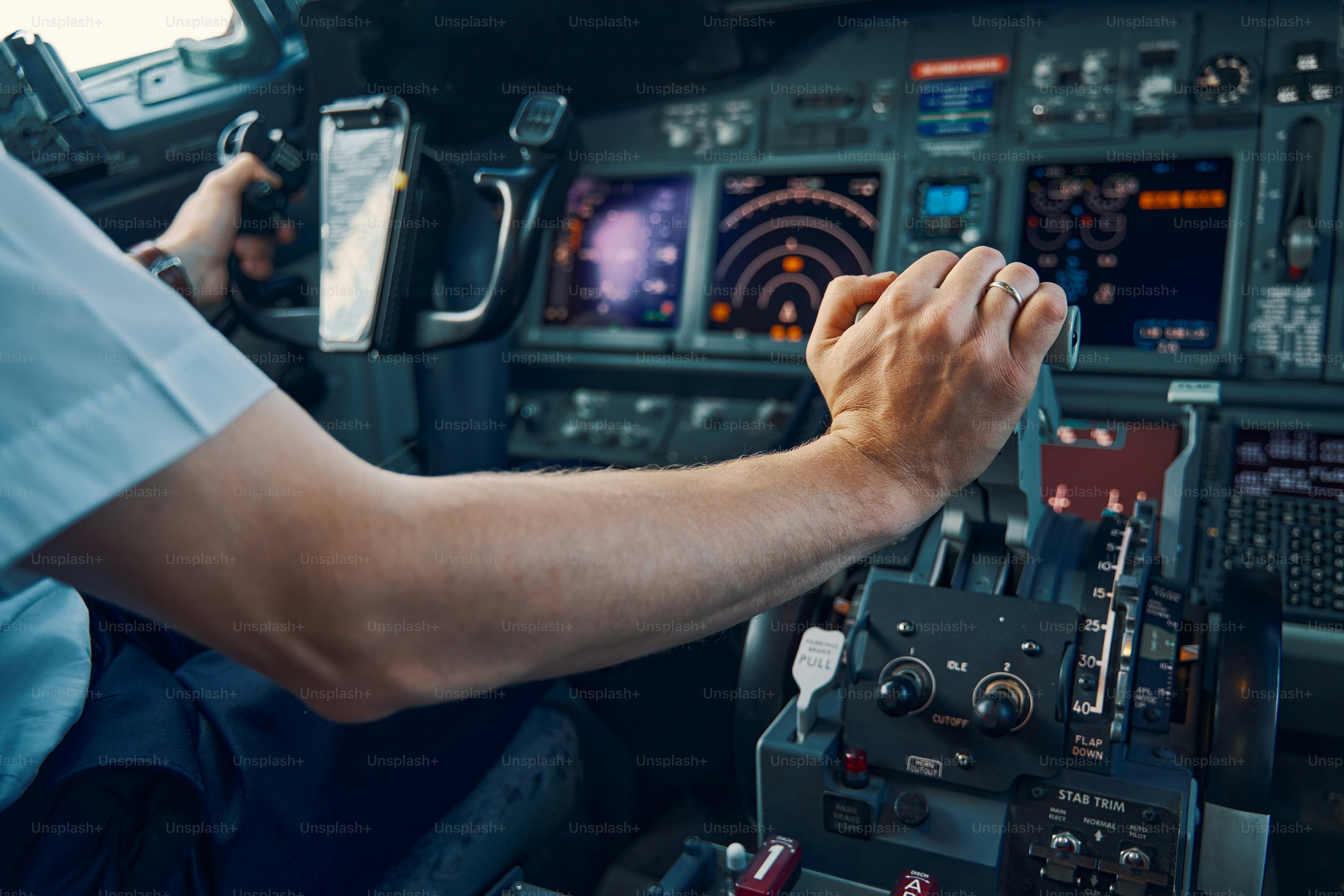 Cropped photo of an experienced airline captain pushing the throttle to ...