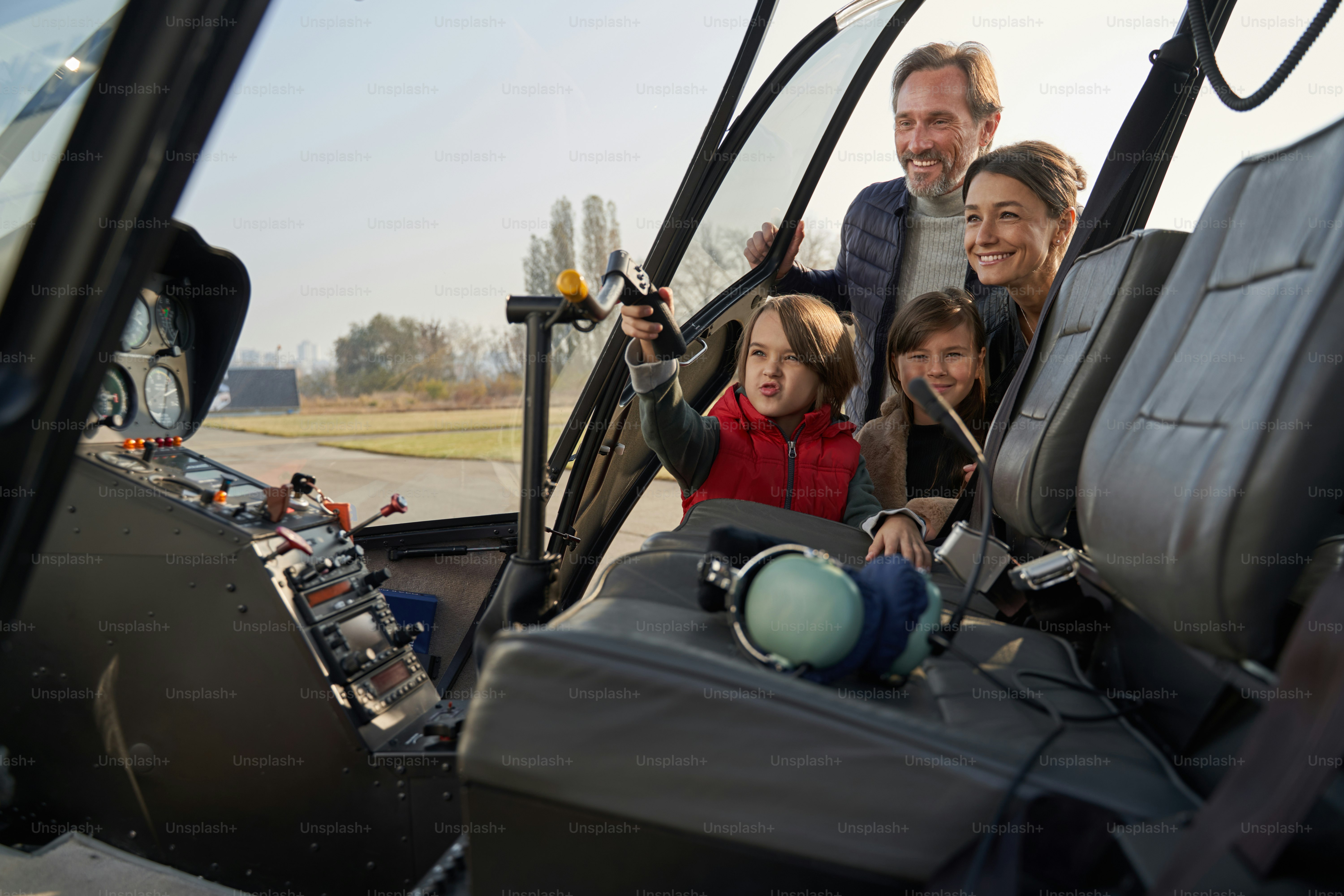 Cheerful parents taking their lovely kids on a thrilling helicopter ...