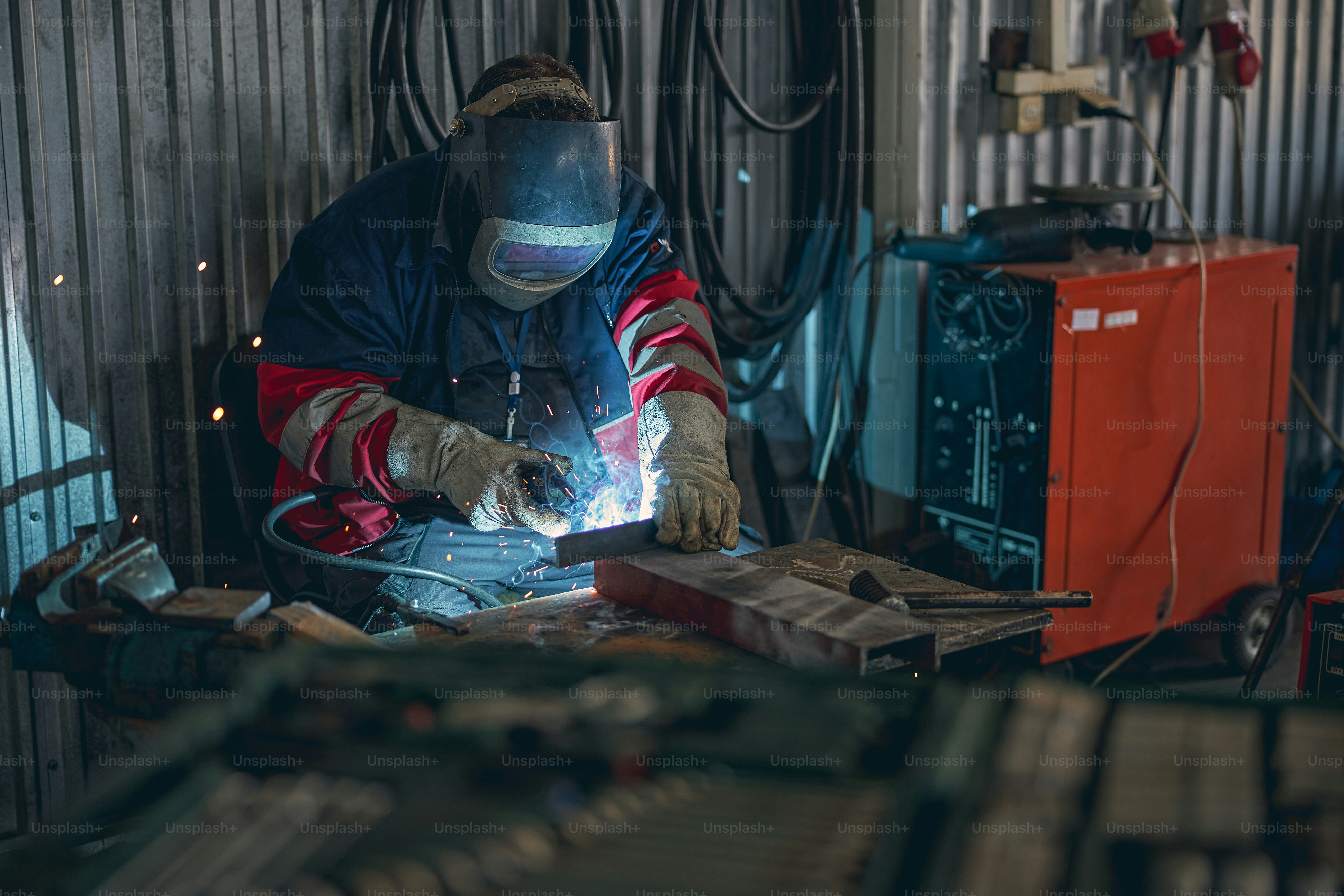 Close up of professional mechanic that bowing his head while welding ...