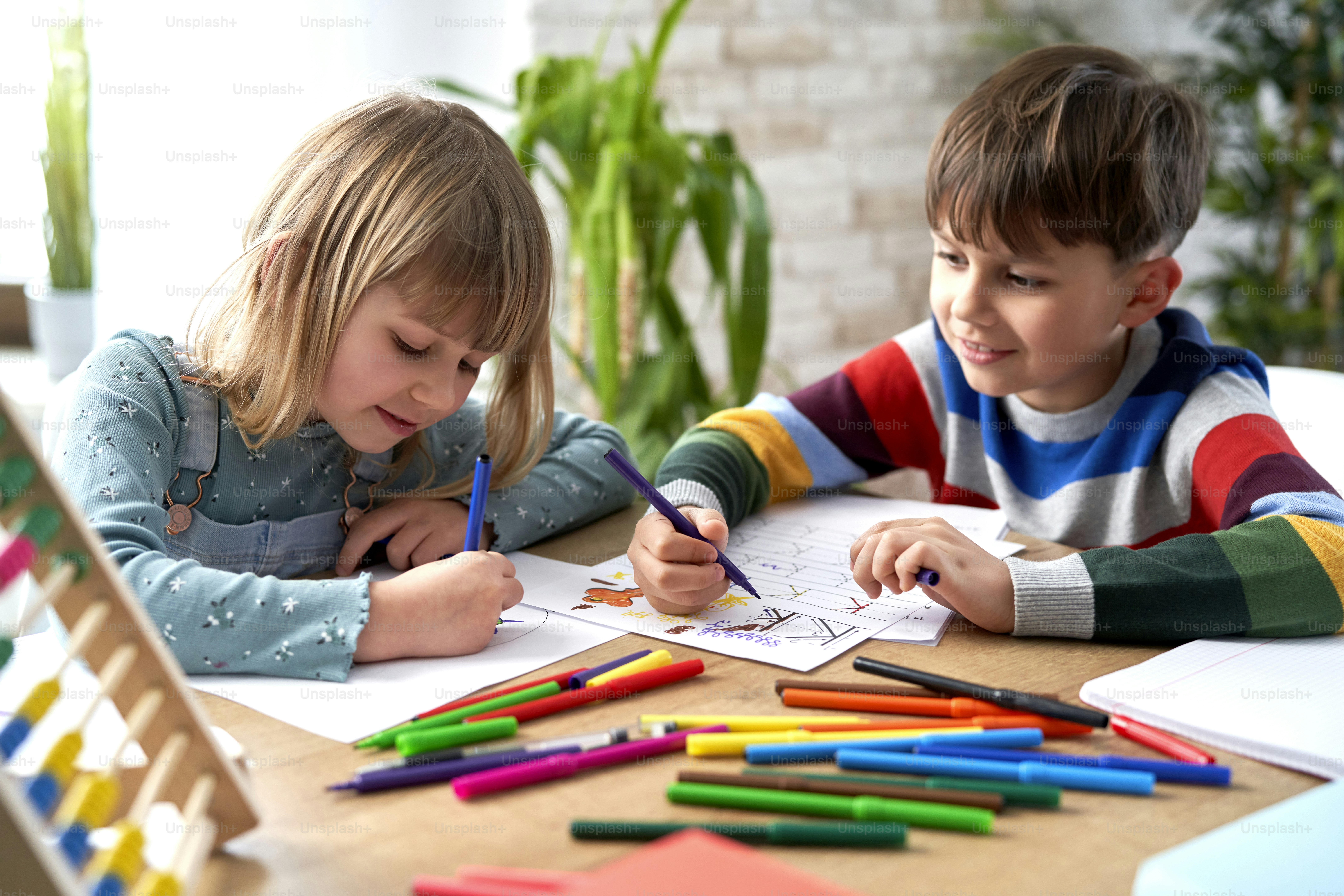 Smiling sibling doing homework together photo – Homeschooling Image on ...