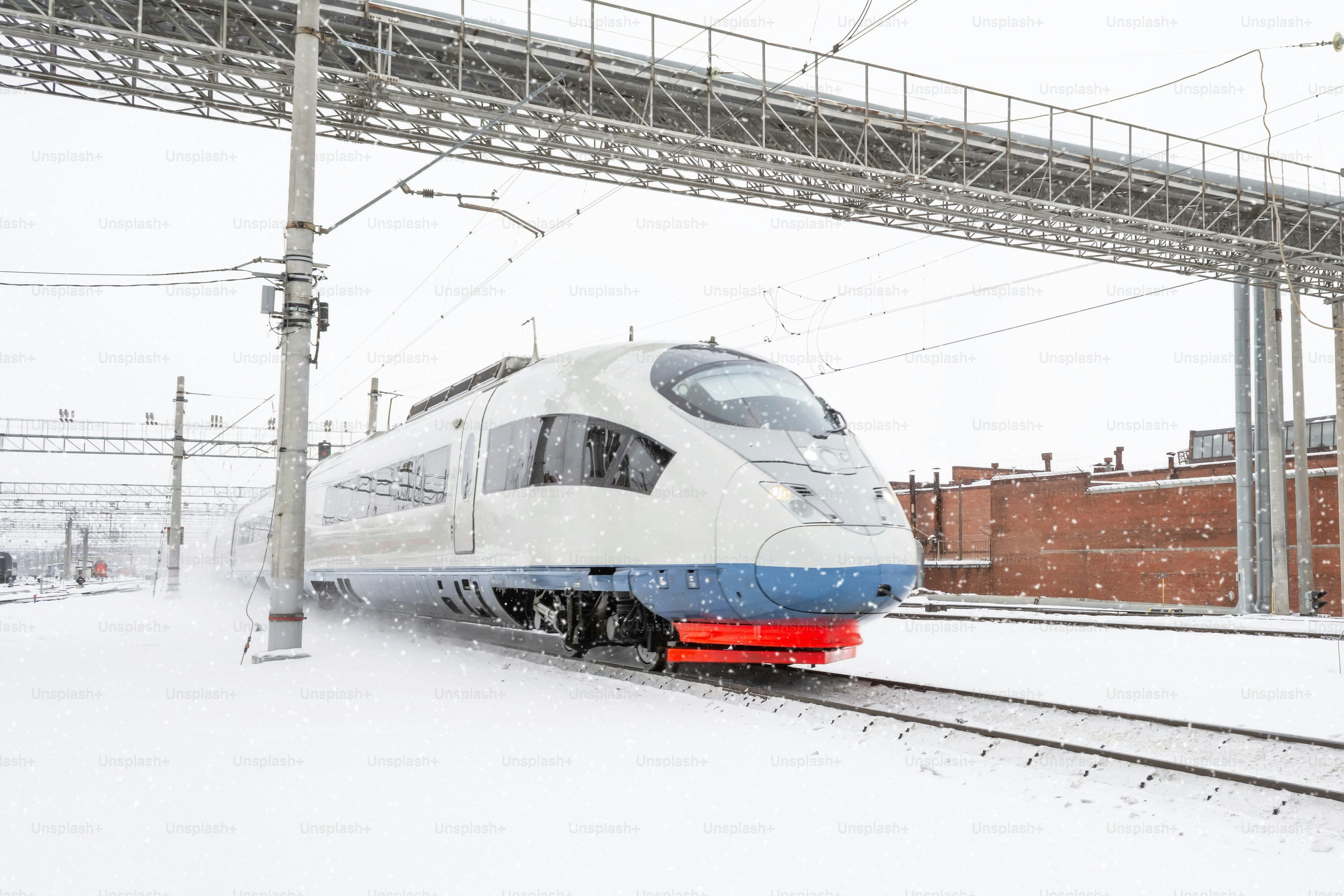 High speed train approaches to the station platform at winter day ...