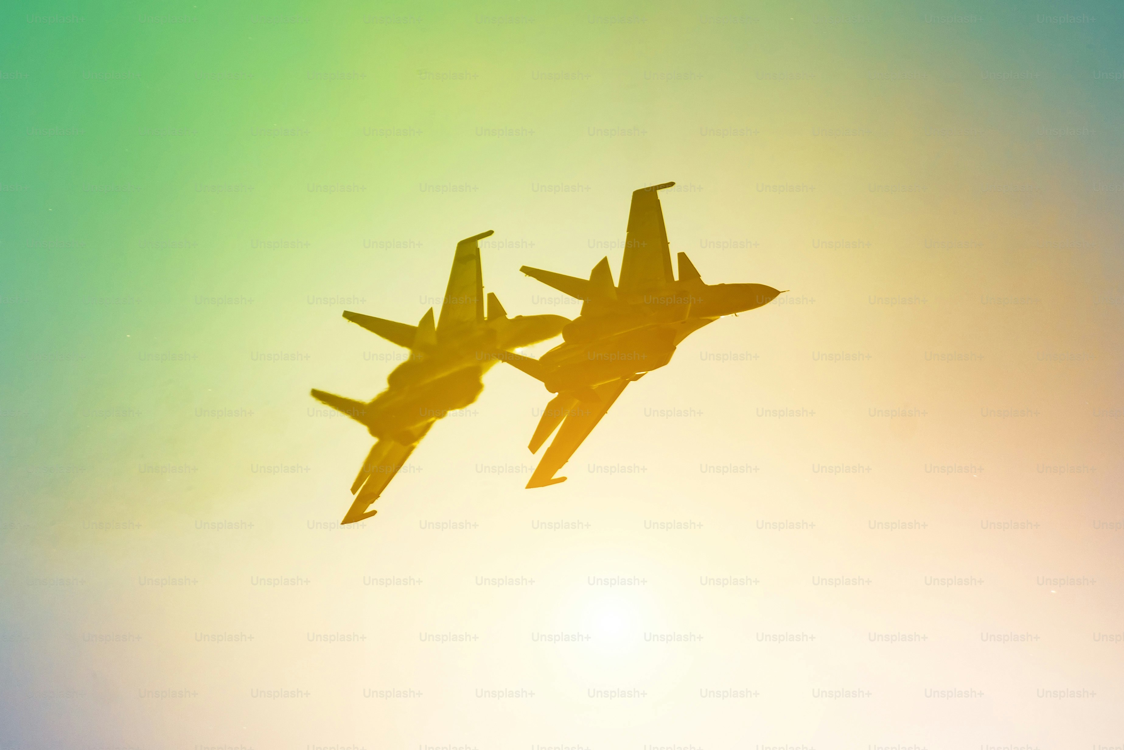 Two aircraft fighter jet airplane sun glow warm yellow orange green ...